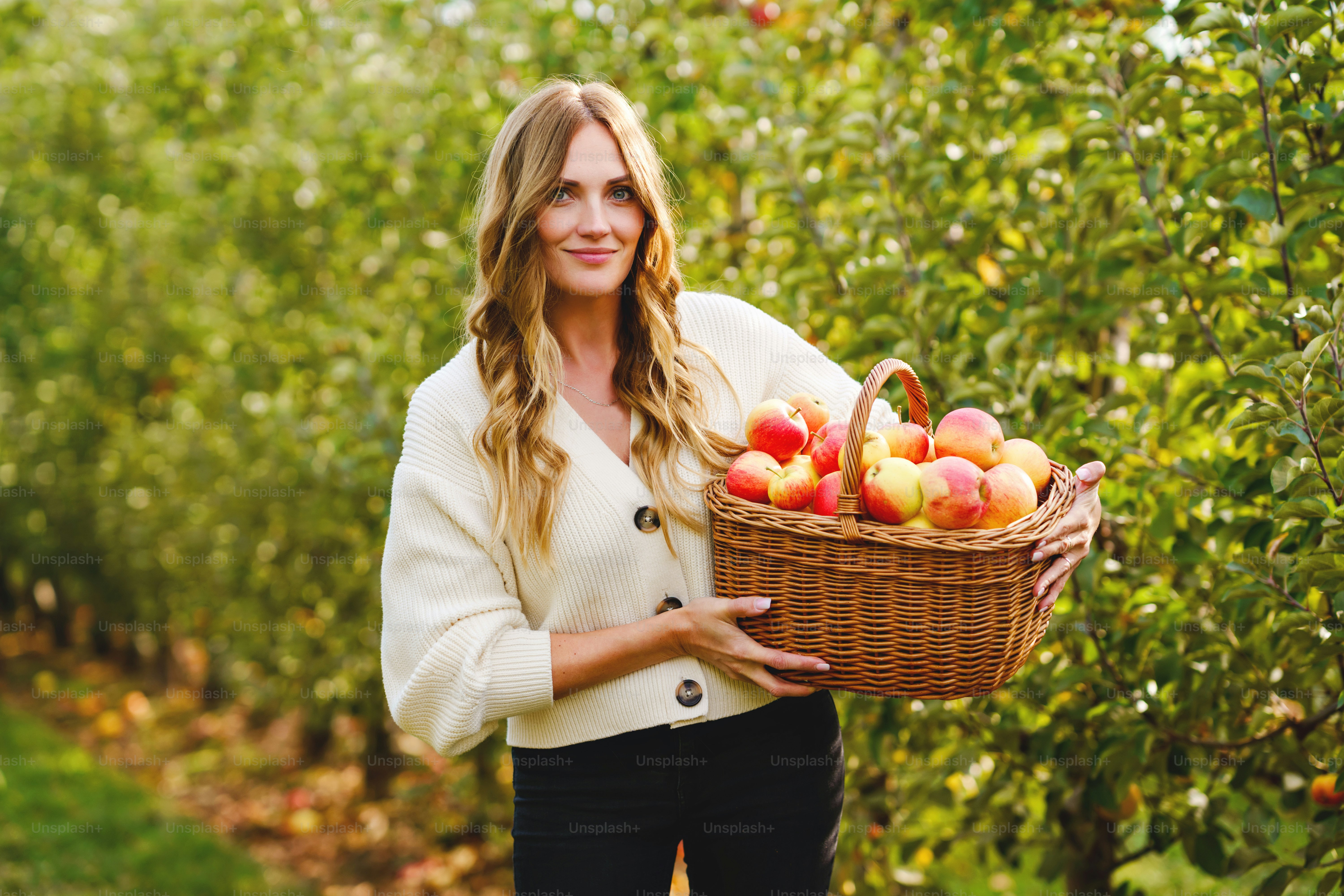 Happy school girl and beautiful mother with red apples in organic ...