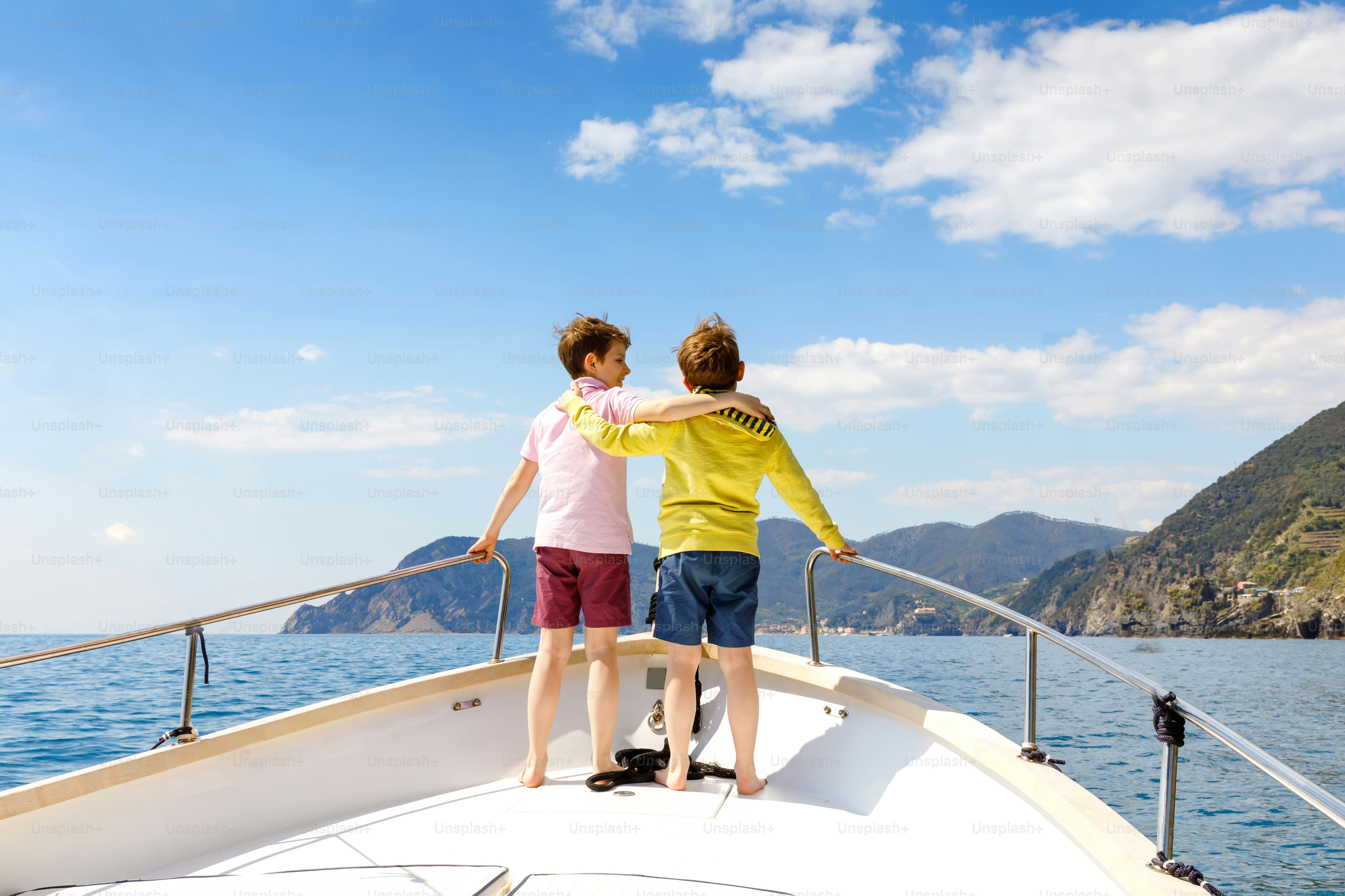 Two little kid boys, best friends enjoying sailing boat trip. Family ...