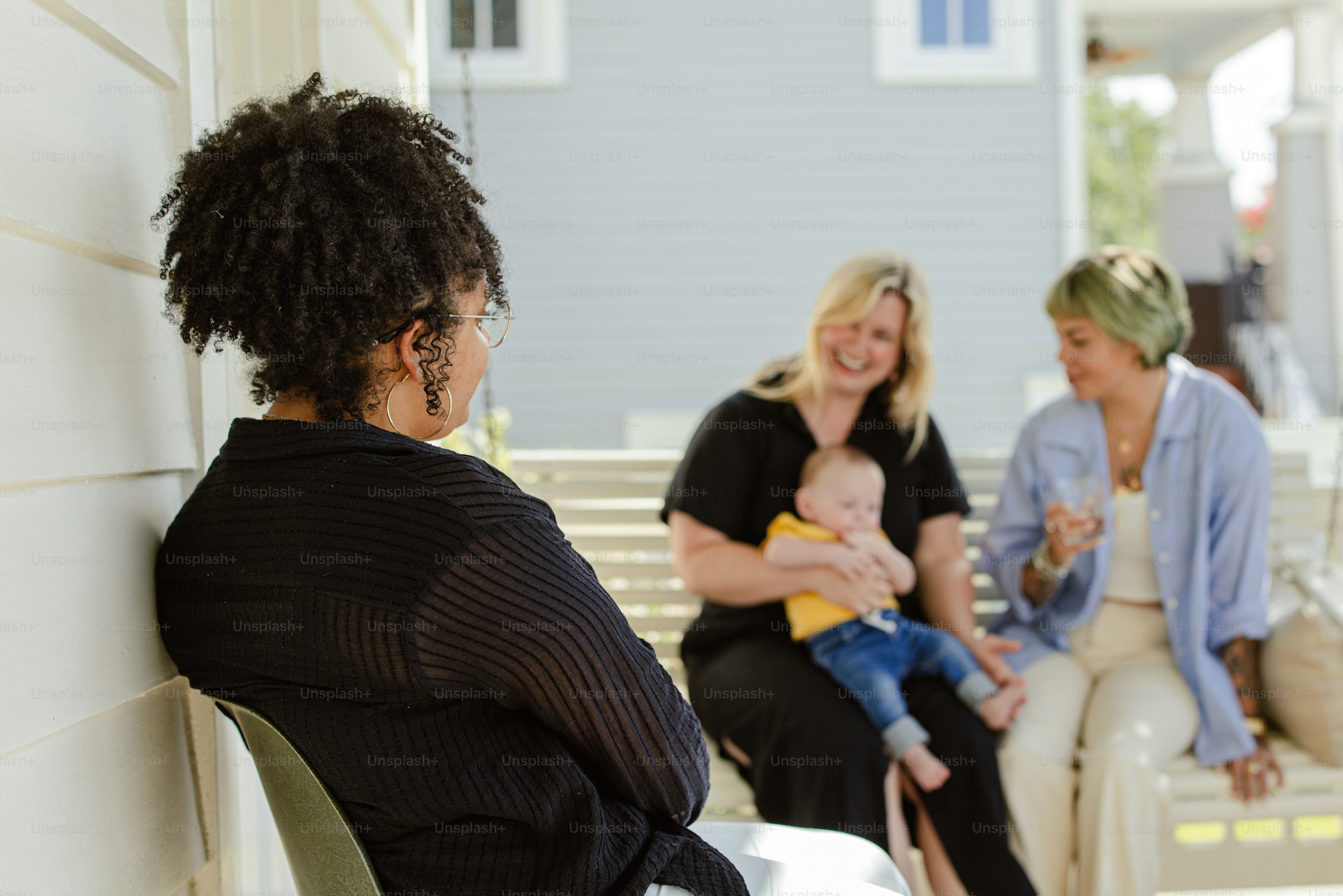 A group of women sitting on top of a porch photo – Porch Image on Unsplash