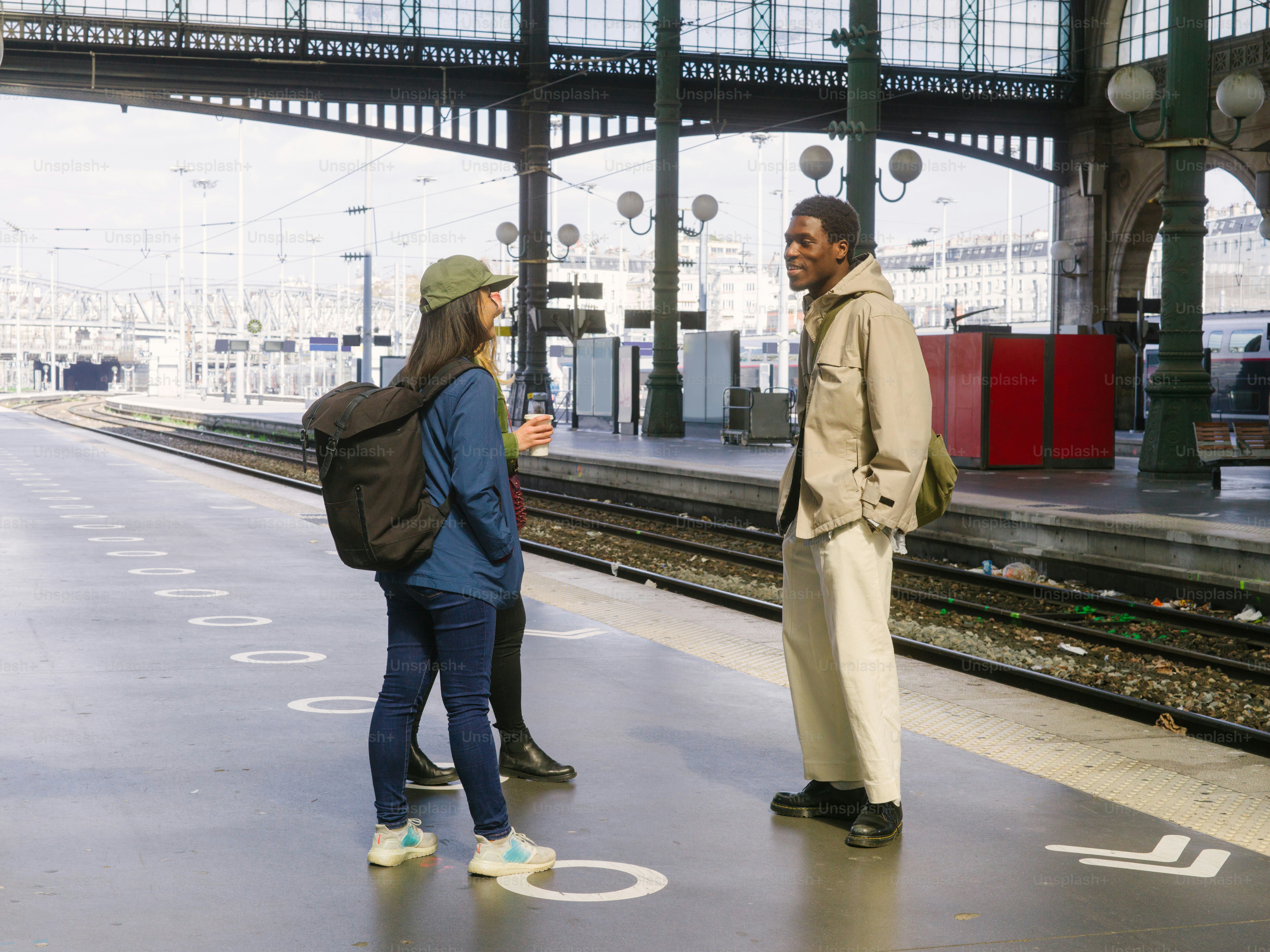 A person with a backpack waiting for a train photo – Interrail Image on ...