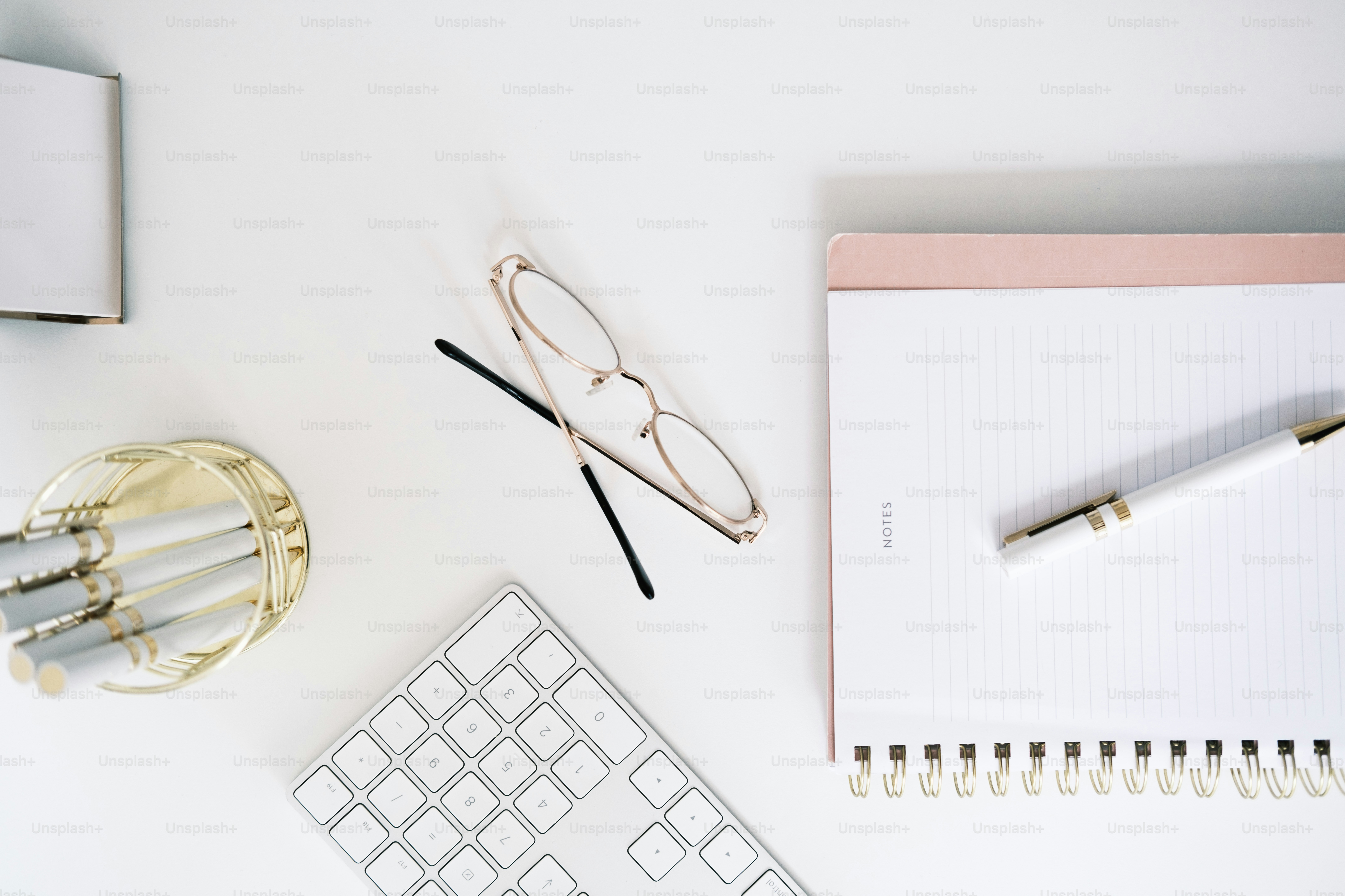 Overhead view woman making notes on notebook and working with laptop ...