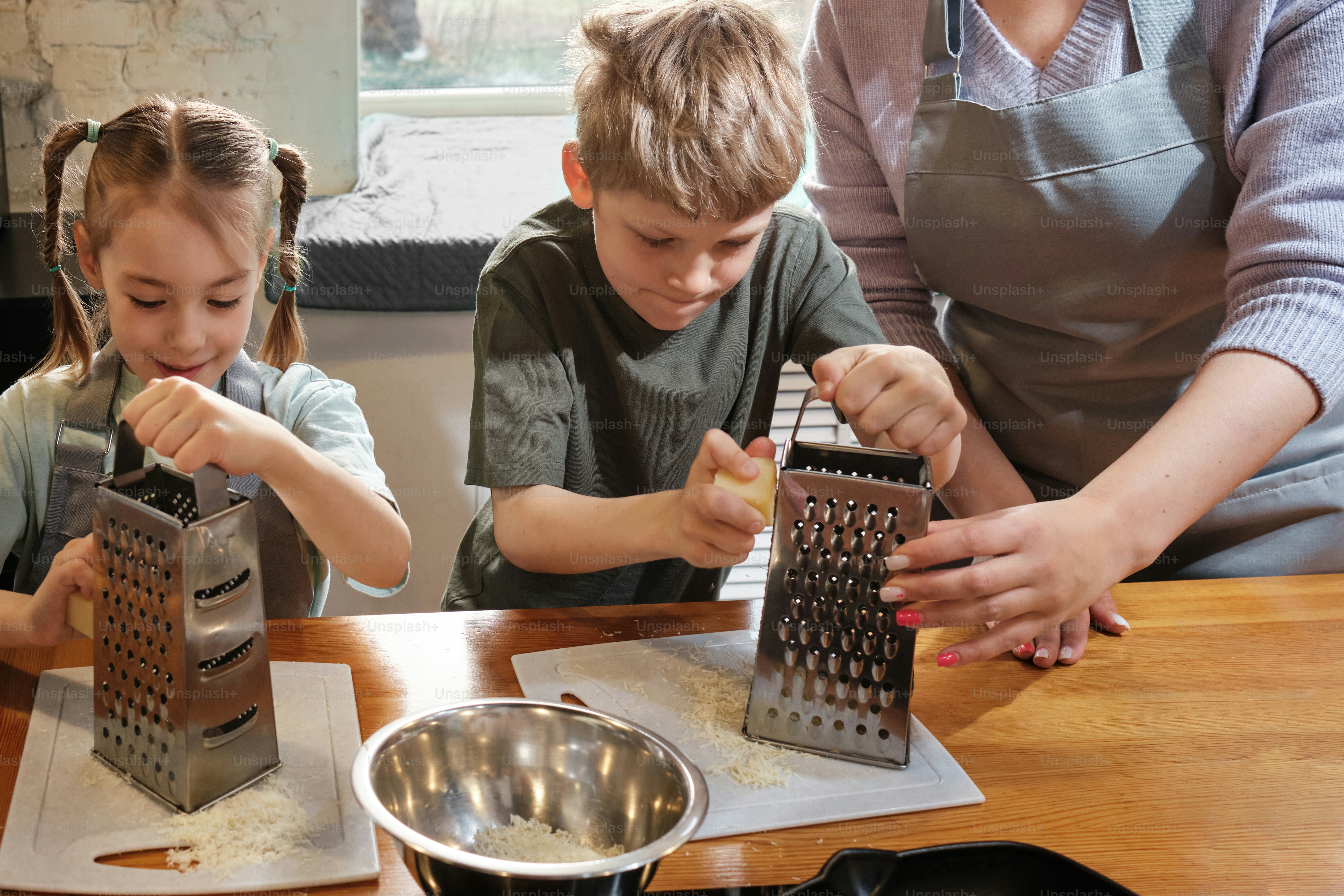 A woman and two children are making graters photo – Cooking class Image ...