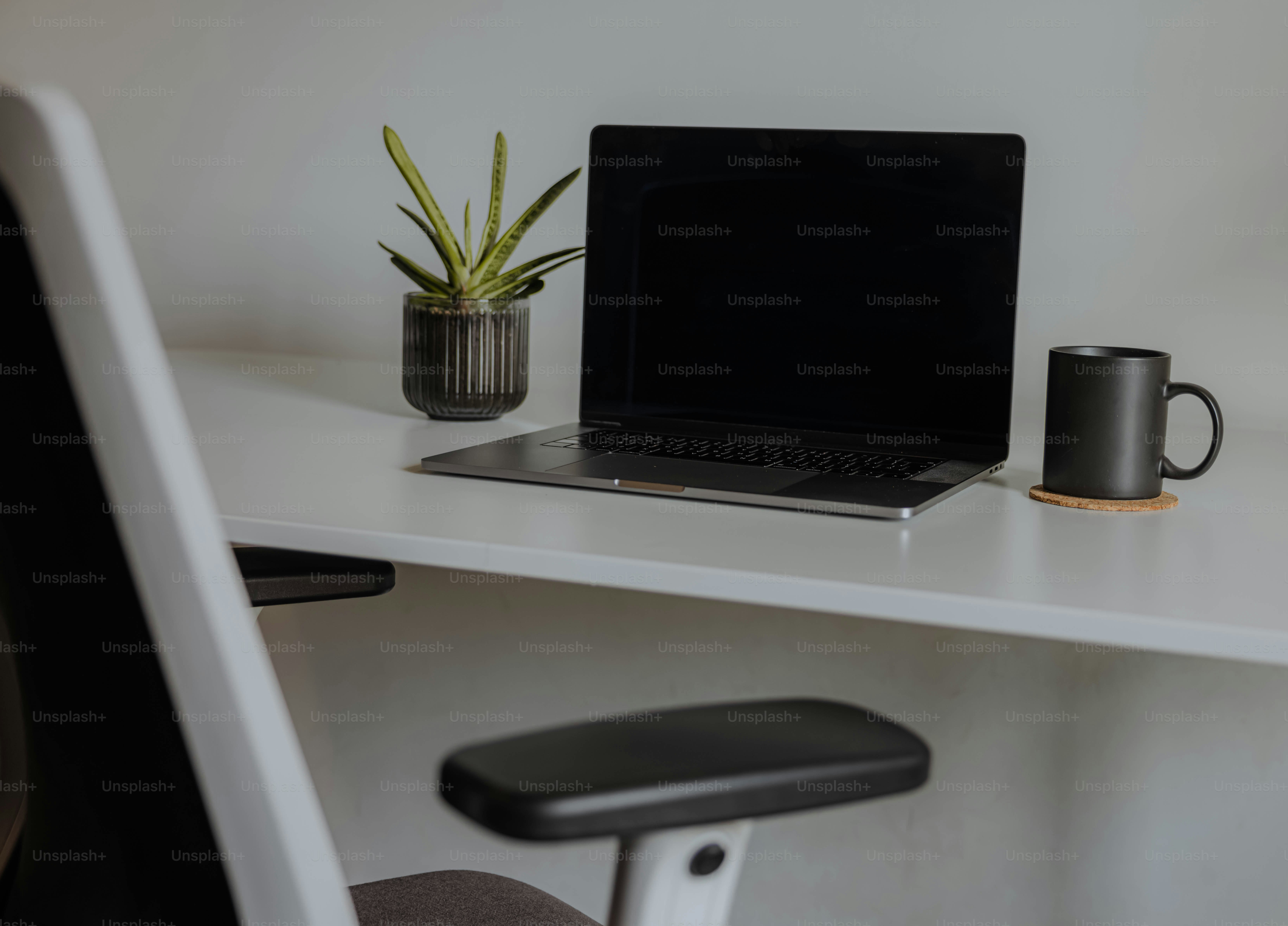 A laptop computer sitting on top of a white desk photo – Out of office ...