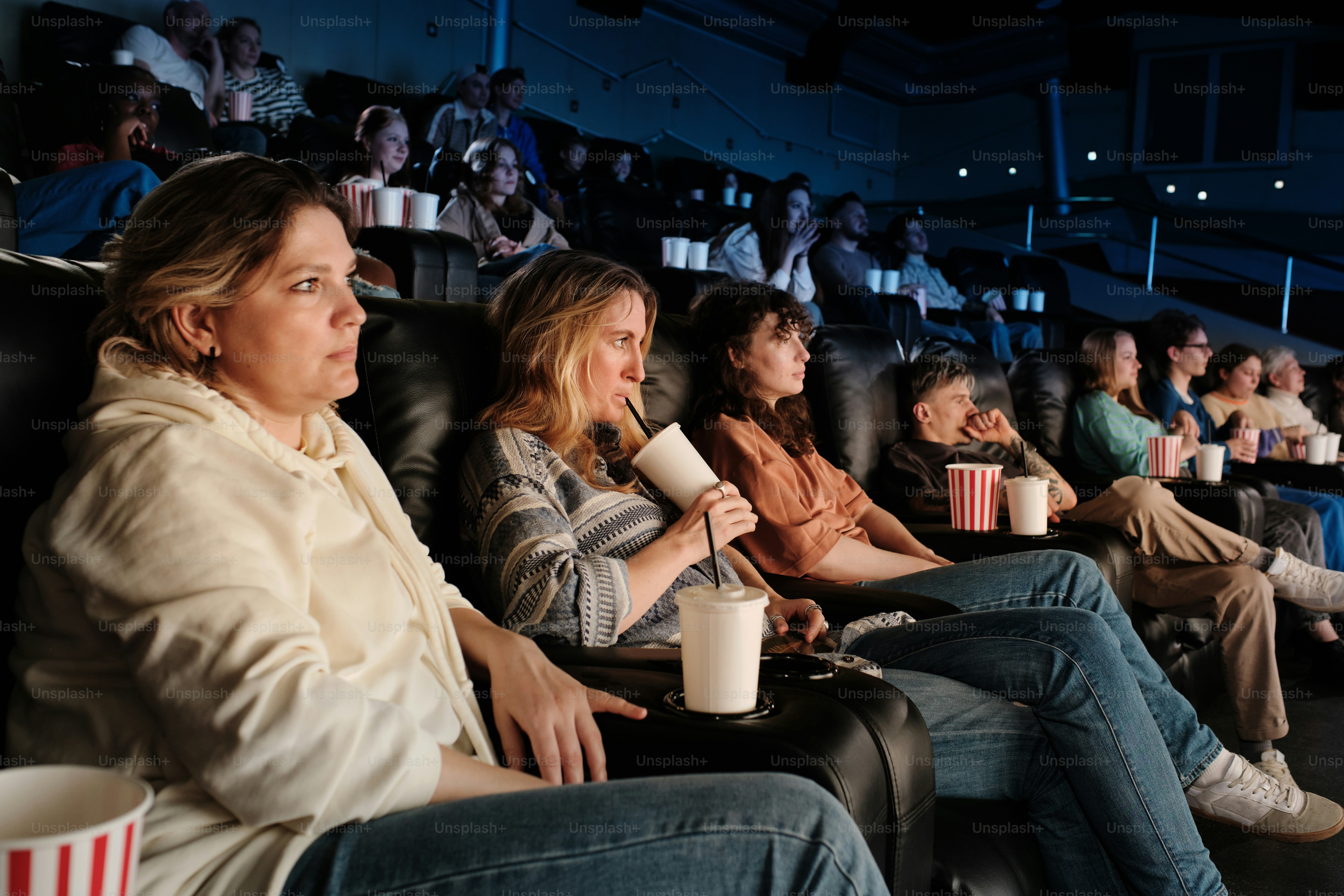 A group of people sitting in a movie theater photo – Film Image on Unsplash