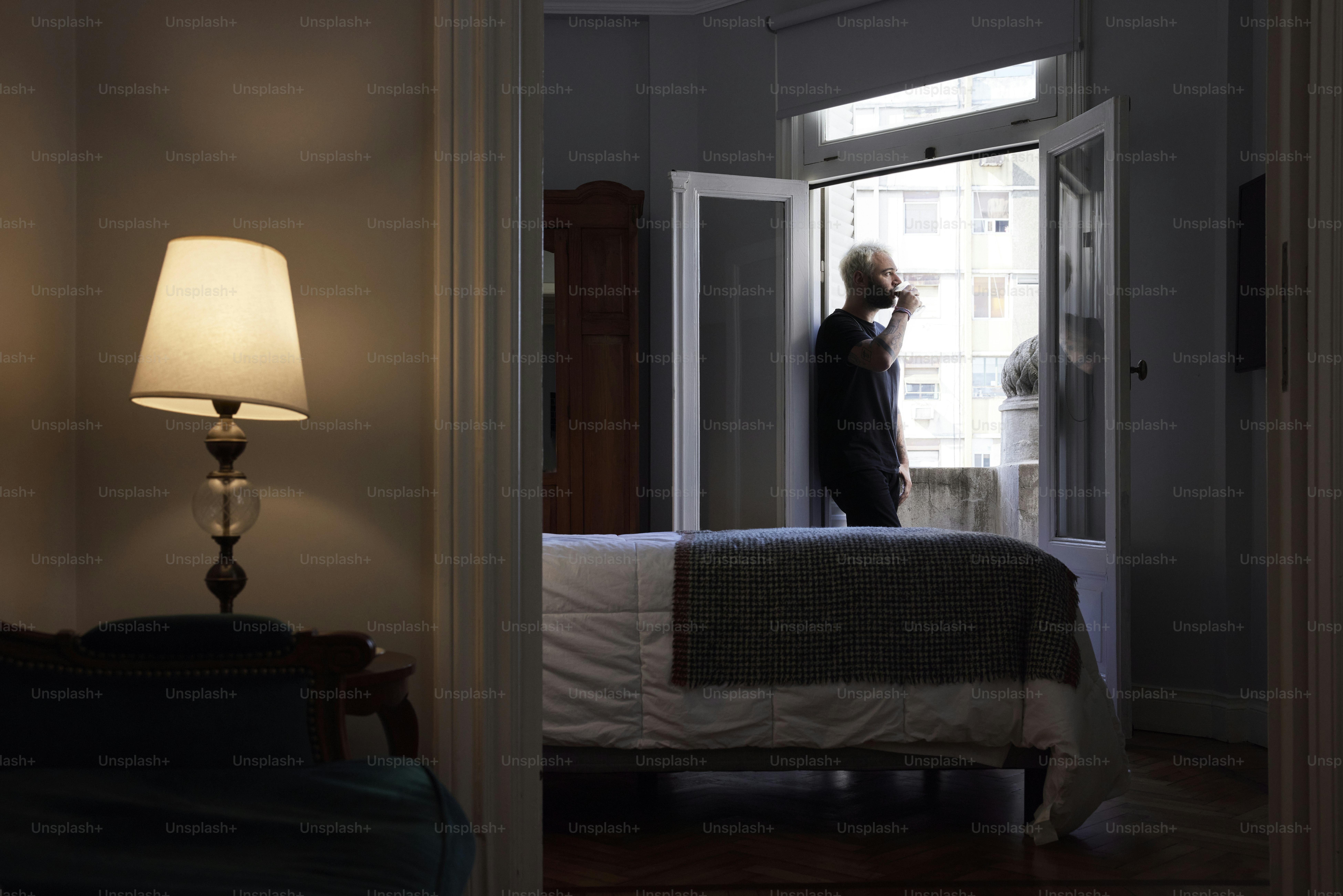 A man standing in the doorway of a bedroom photo – Bedroom Image on ...