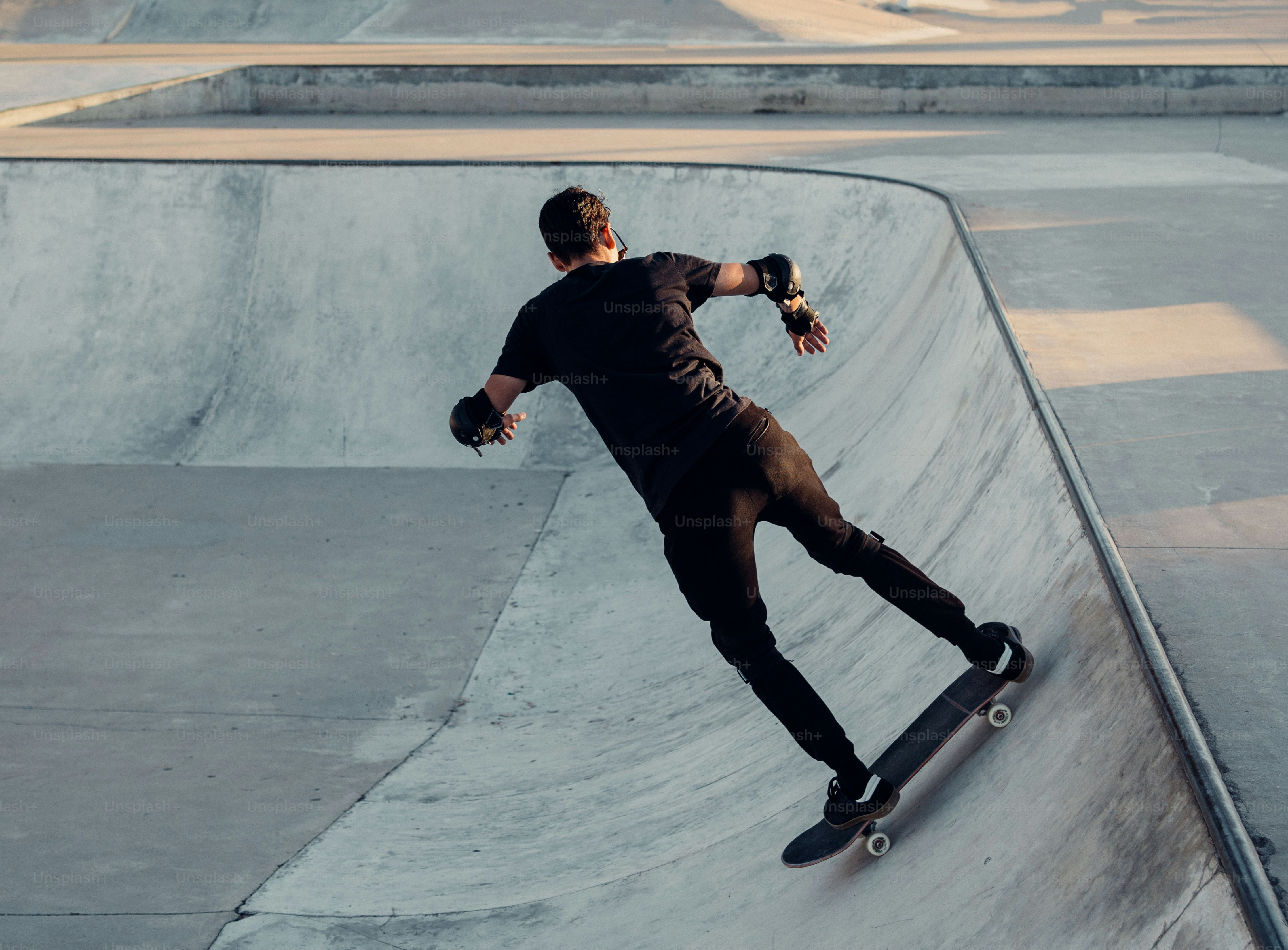 A man riding a skateboard up the side of a ramp photo – Trying Image on ...