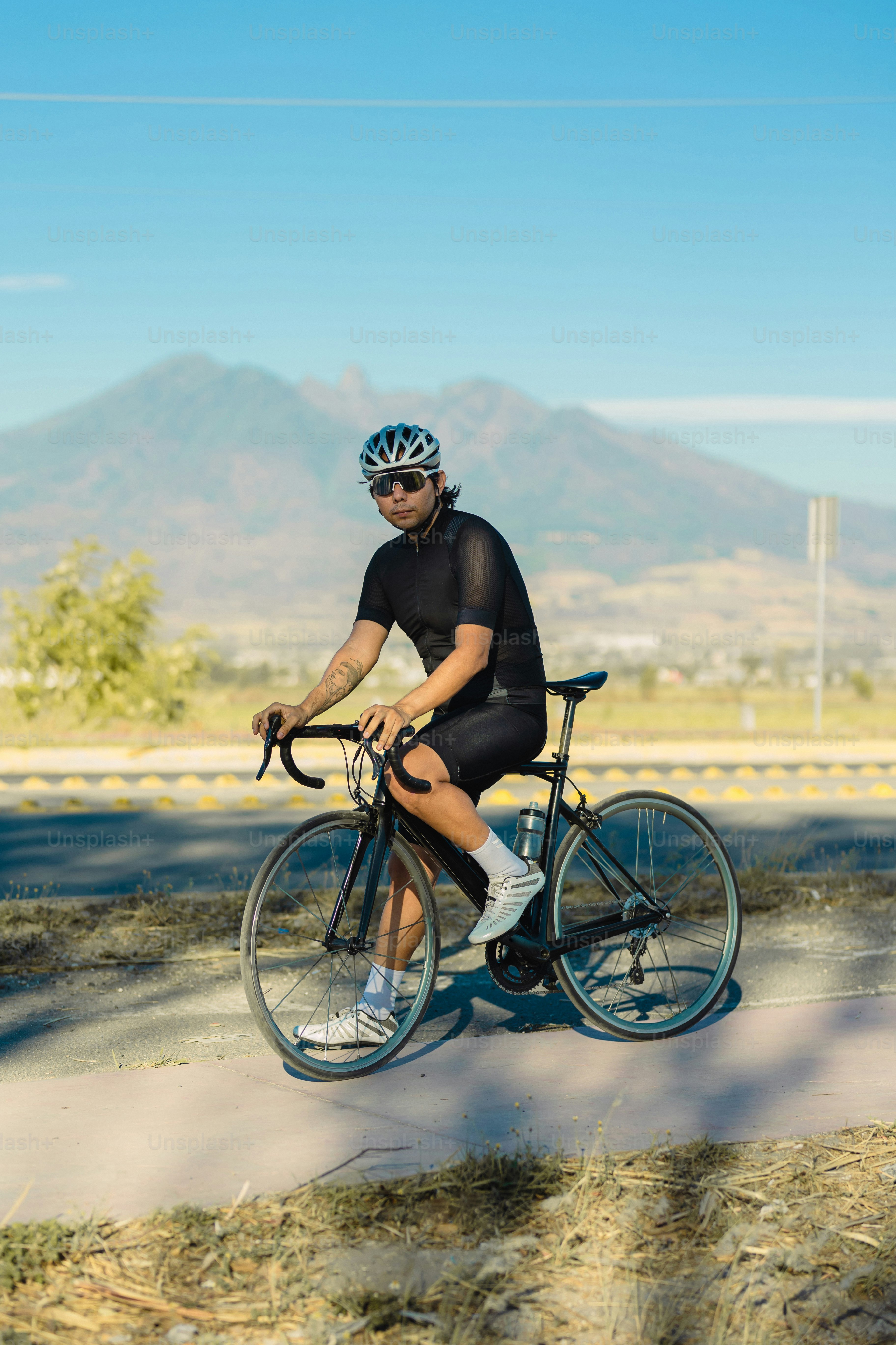 A man riding a bike down a street photo – Cycling Image on Unsplash