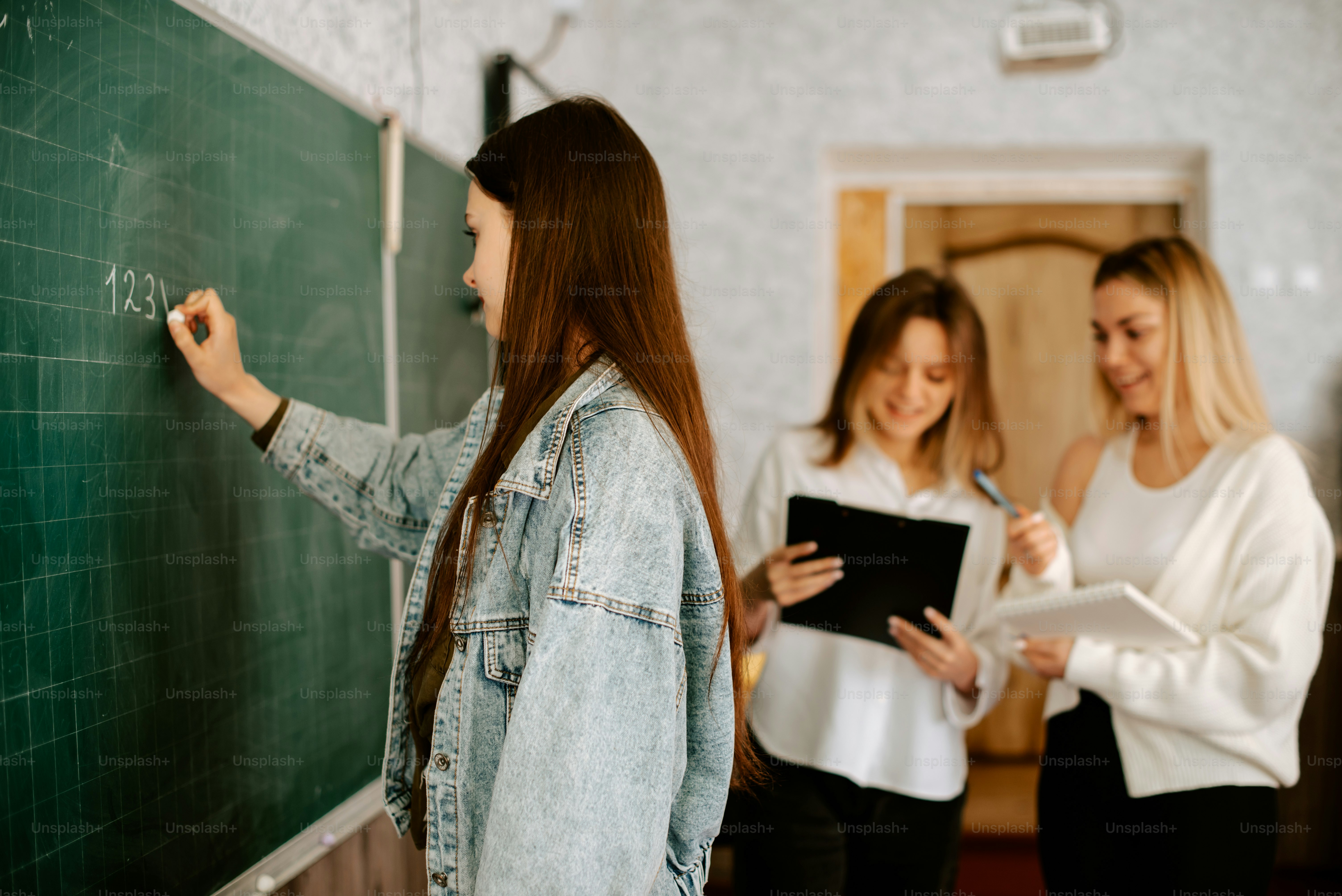 A group of young women writing on a blackboard photo – Chalkboard Image ...