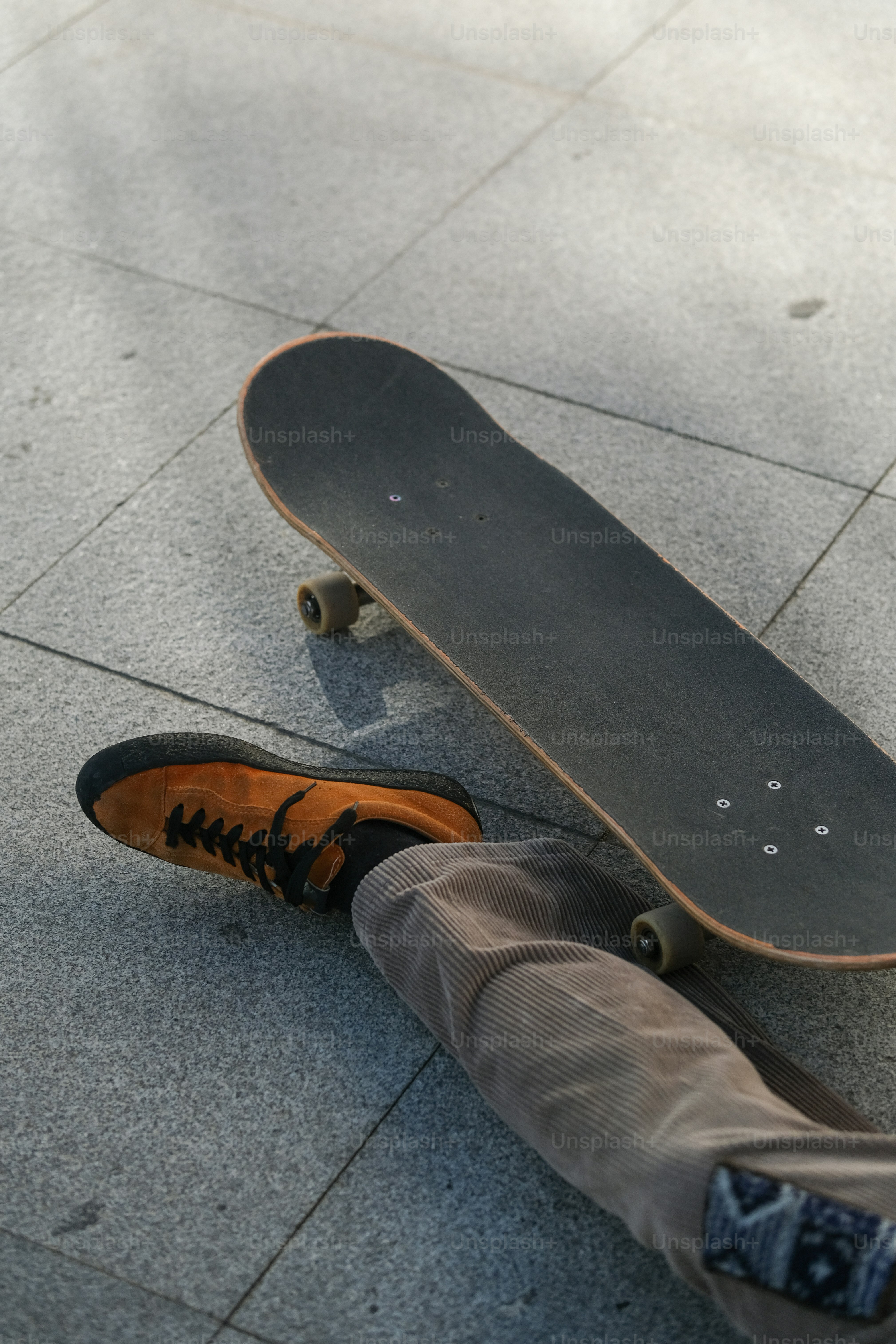 A person laying on the ground next to a skateboard photo – Skate Image ...