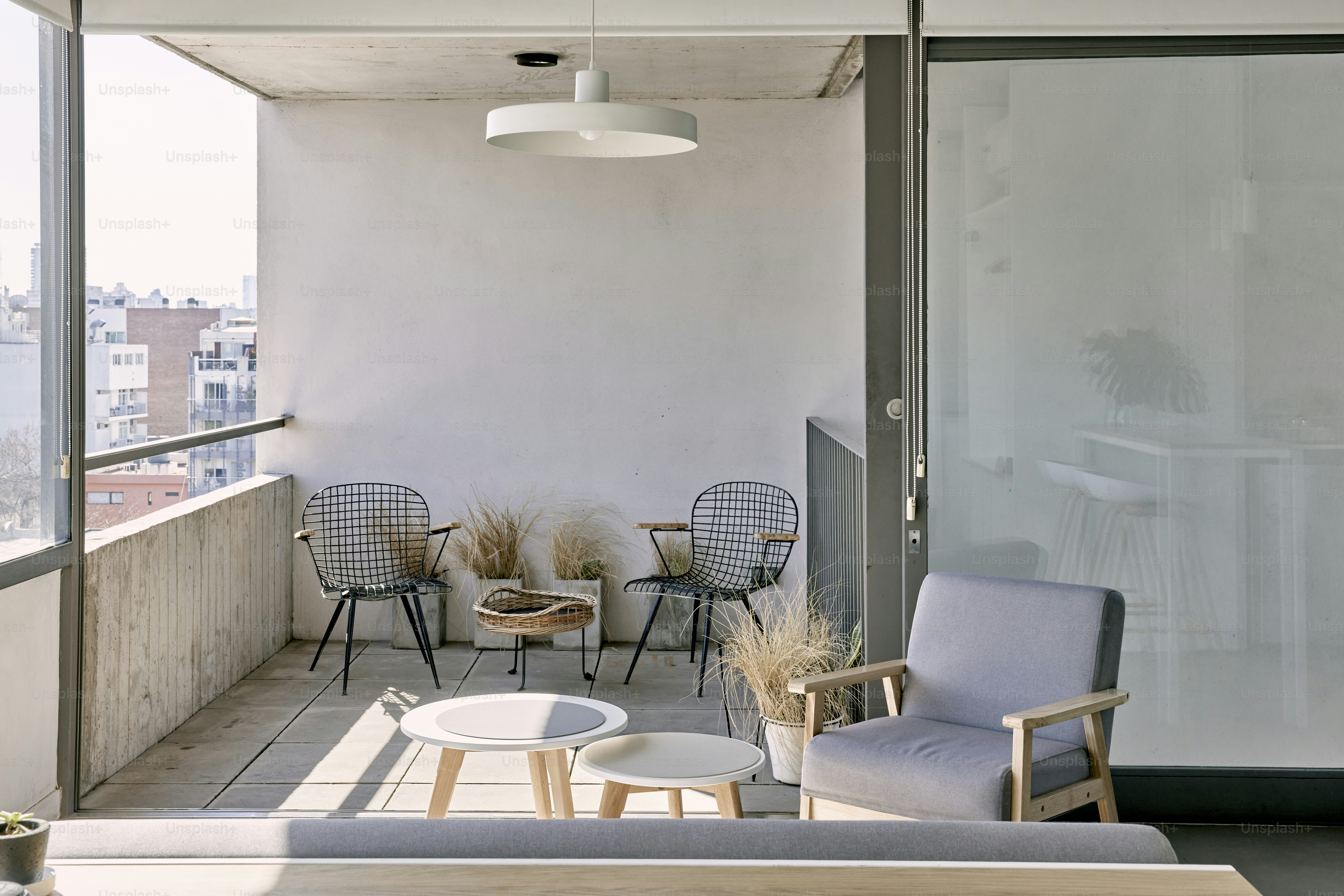 A balcony with a table, chairs and a couch photo – Grey Image on Unsplash