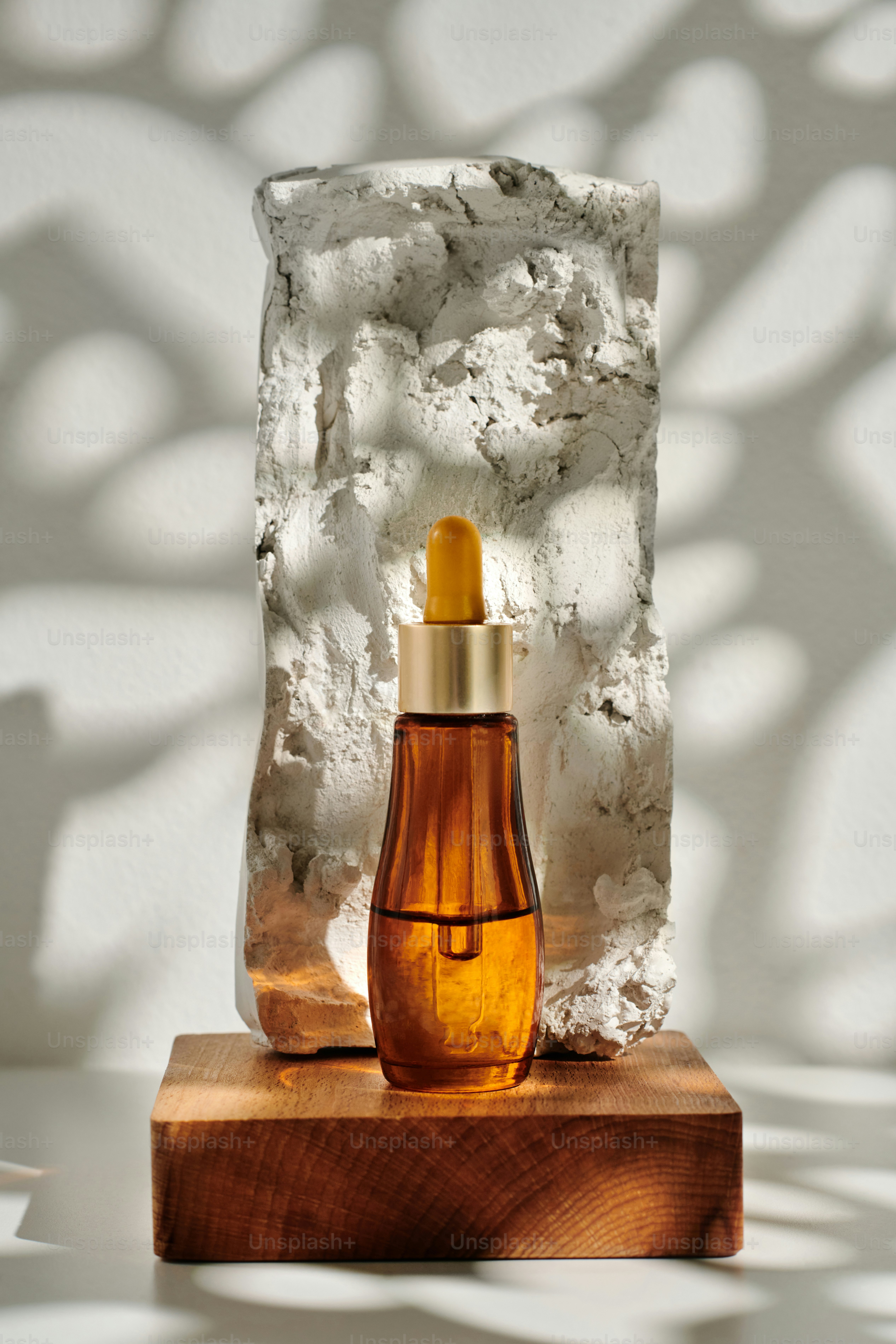 Craft paper bag mockup with green leaves on pink background. Zero waste ...