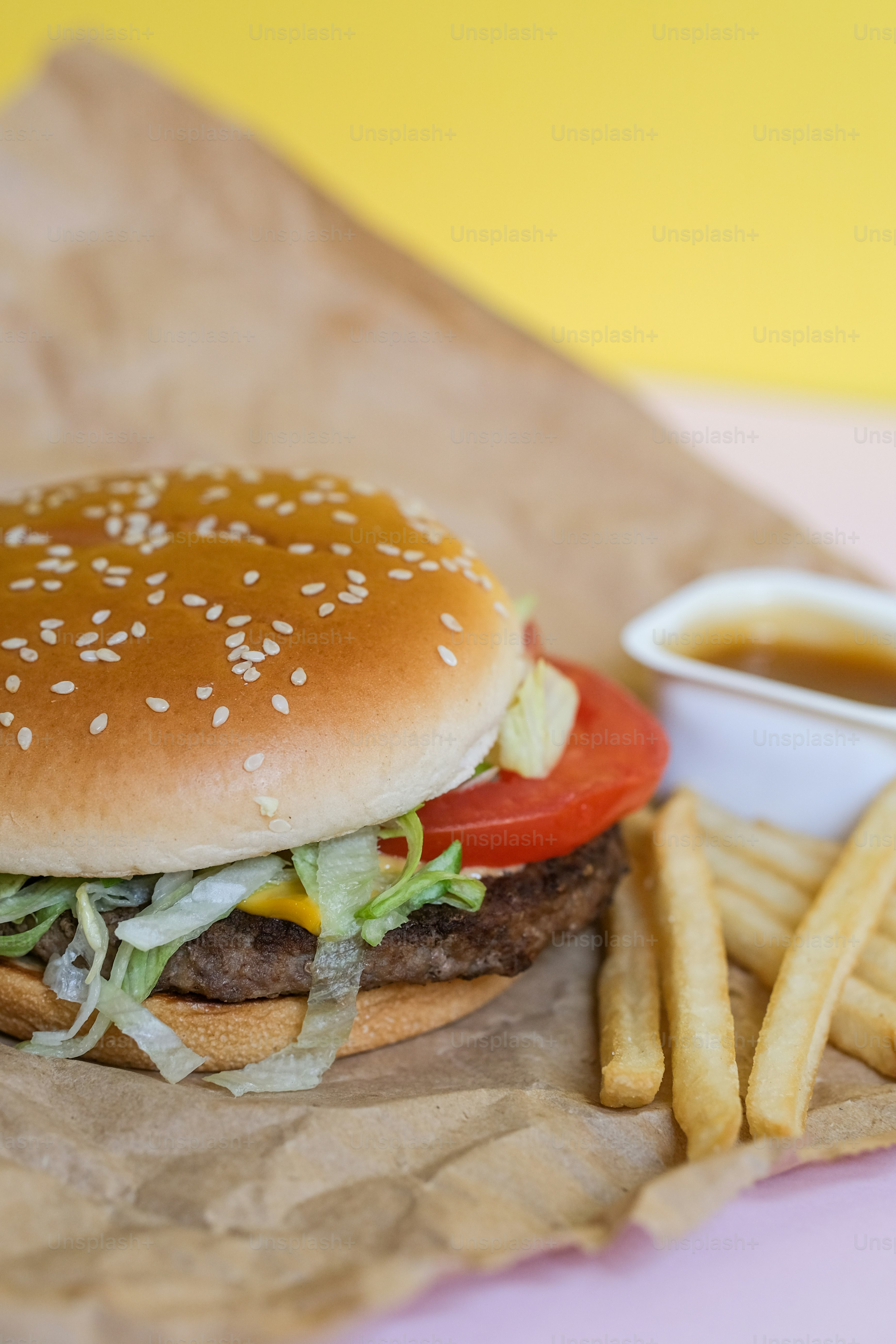 A hamburger and french fries on a piece of wax paper photo – Burgers ...
