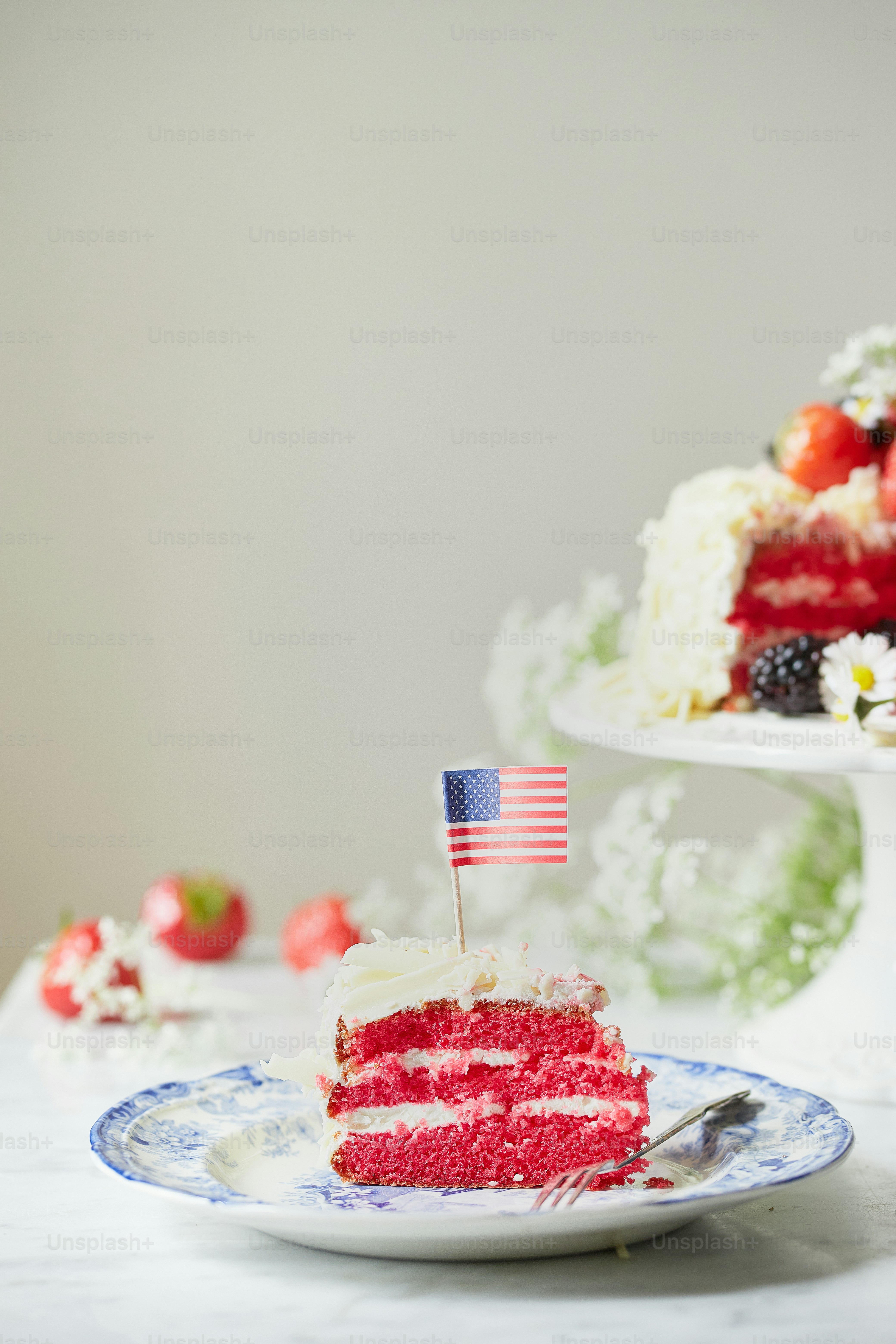 A piece of cake with a flag on top of it photo – Party food Image on ...