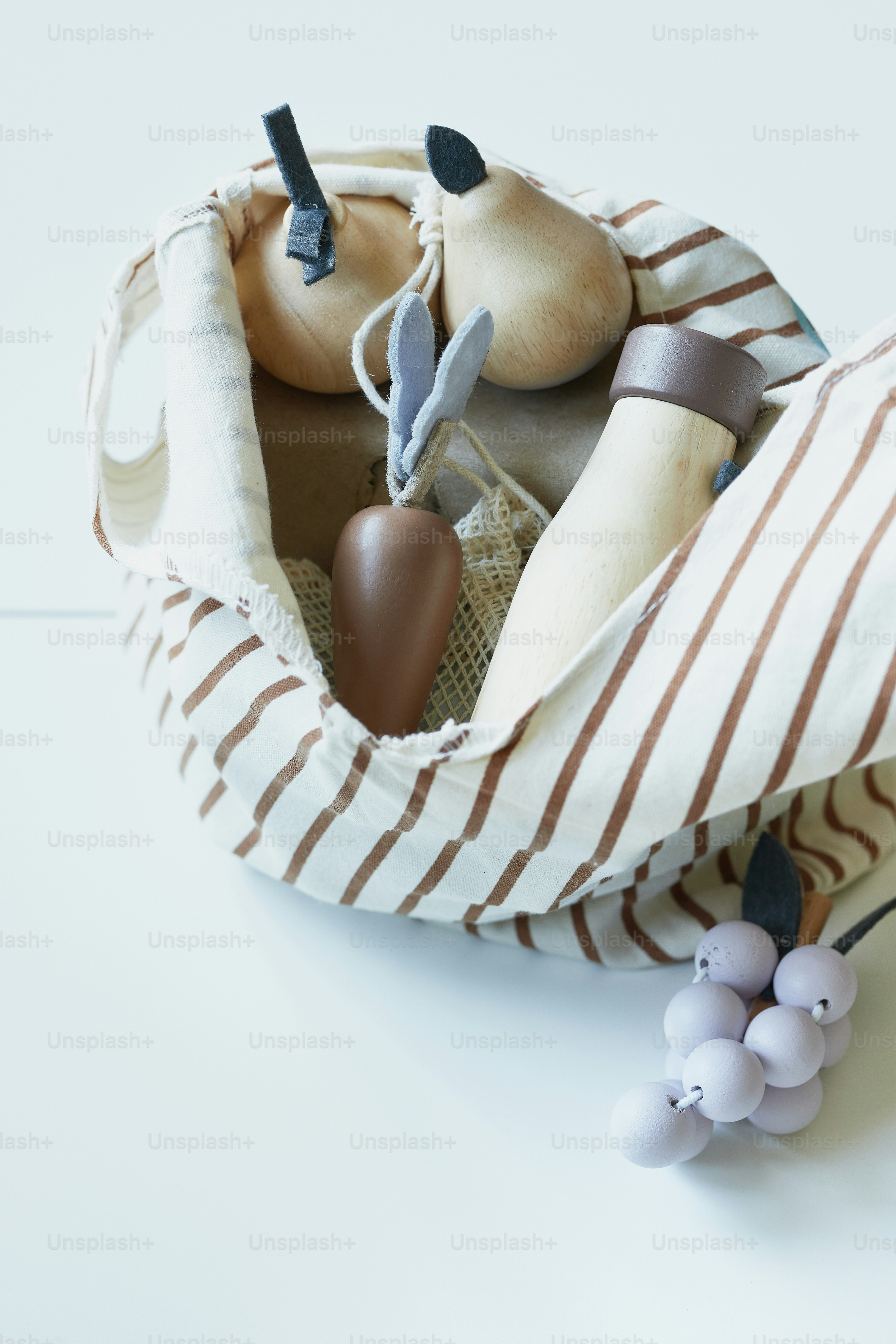 A striped bag filled with different types of items photo – Toys Image ...