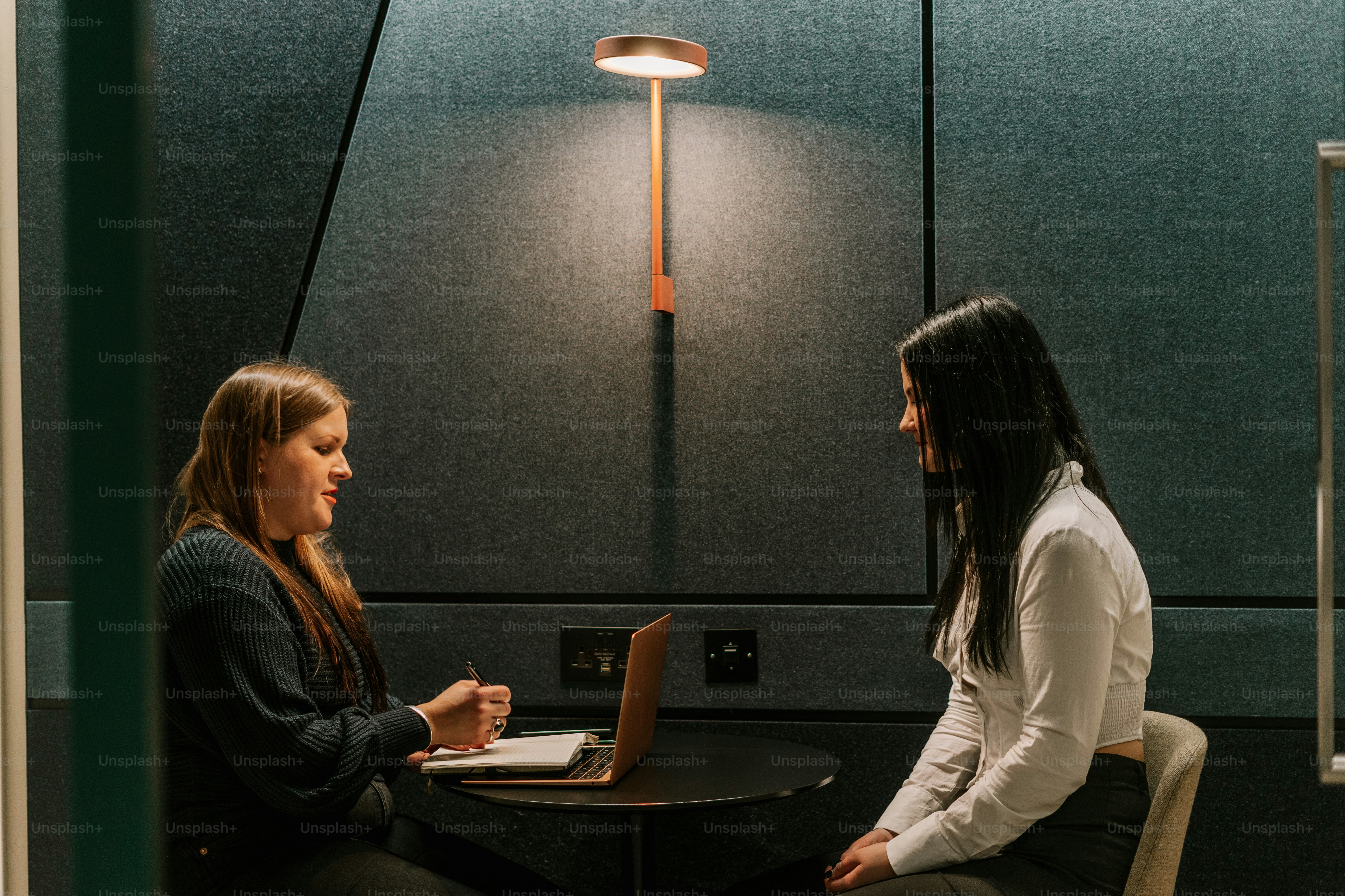 Two women sitting at a table with a laptop photo – Interview setup ...