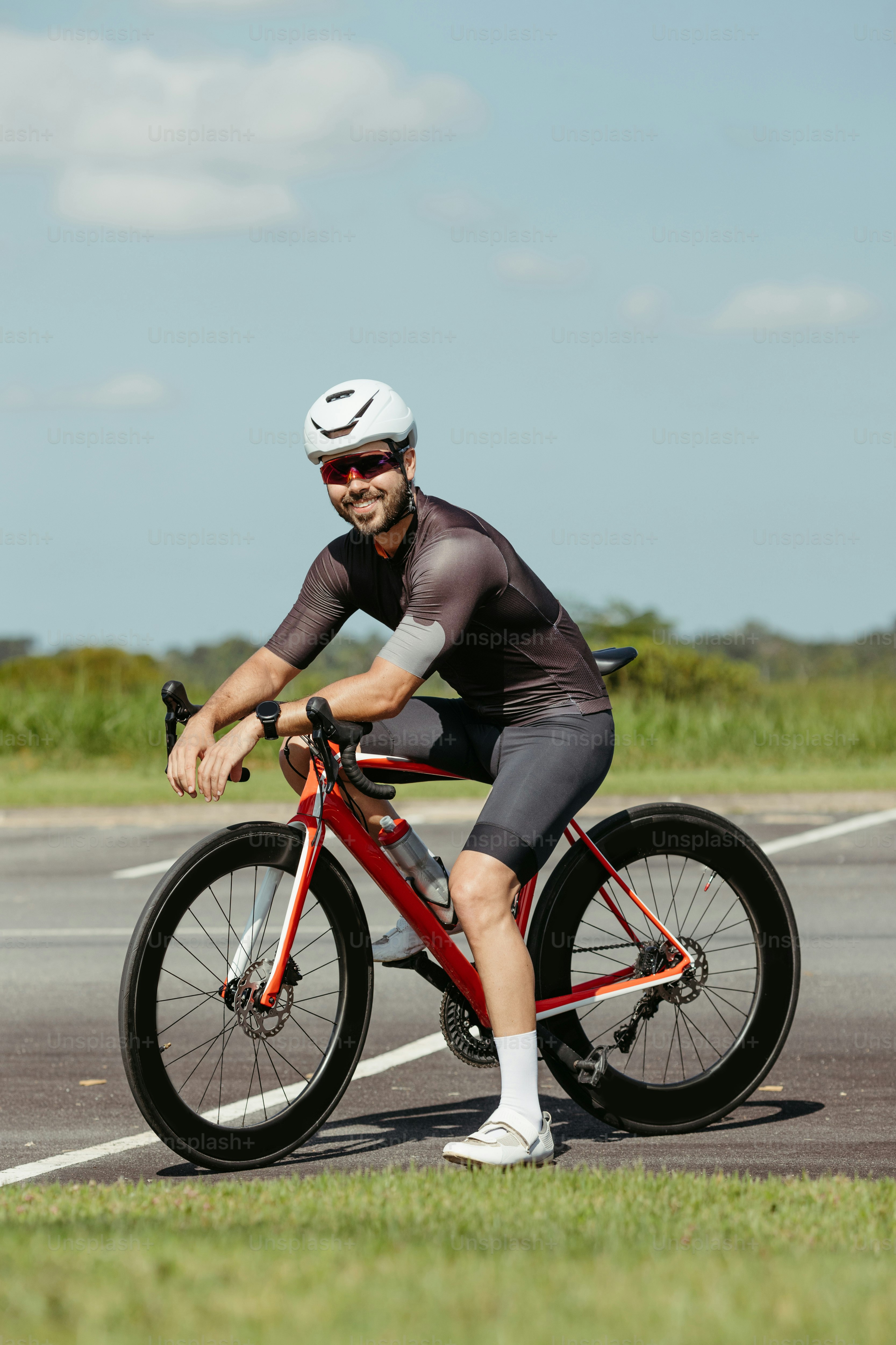 A man riding a bike down a street photo – Sport Image on Unsplash