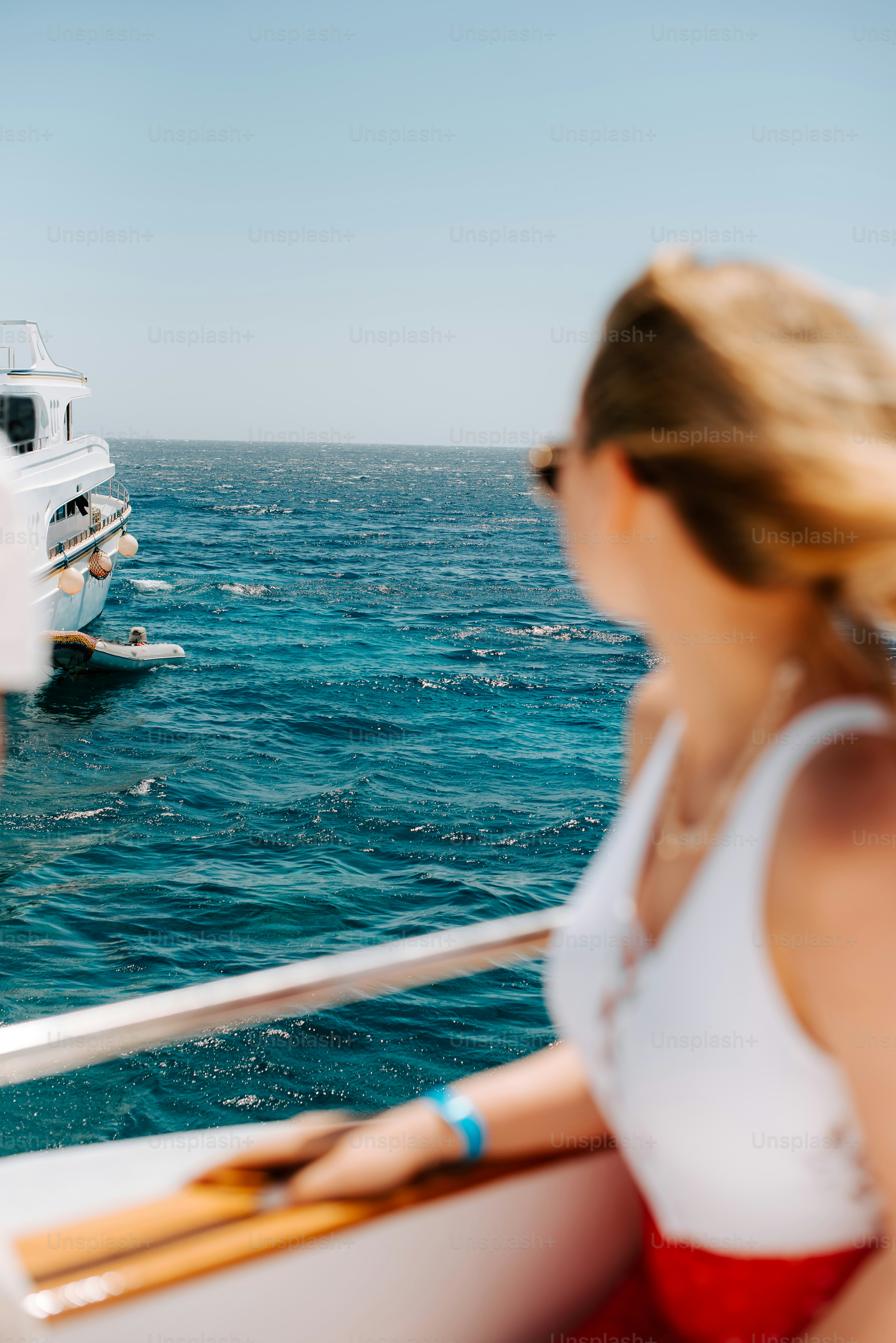 A woman in a white top is on a boat photo – Sailing Image on Unsplash