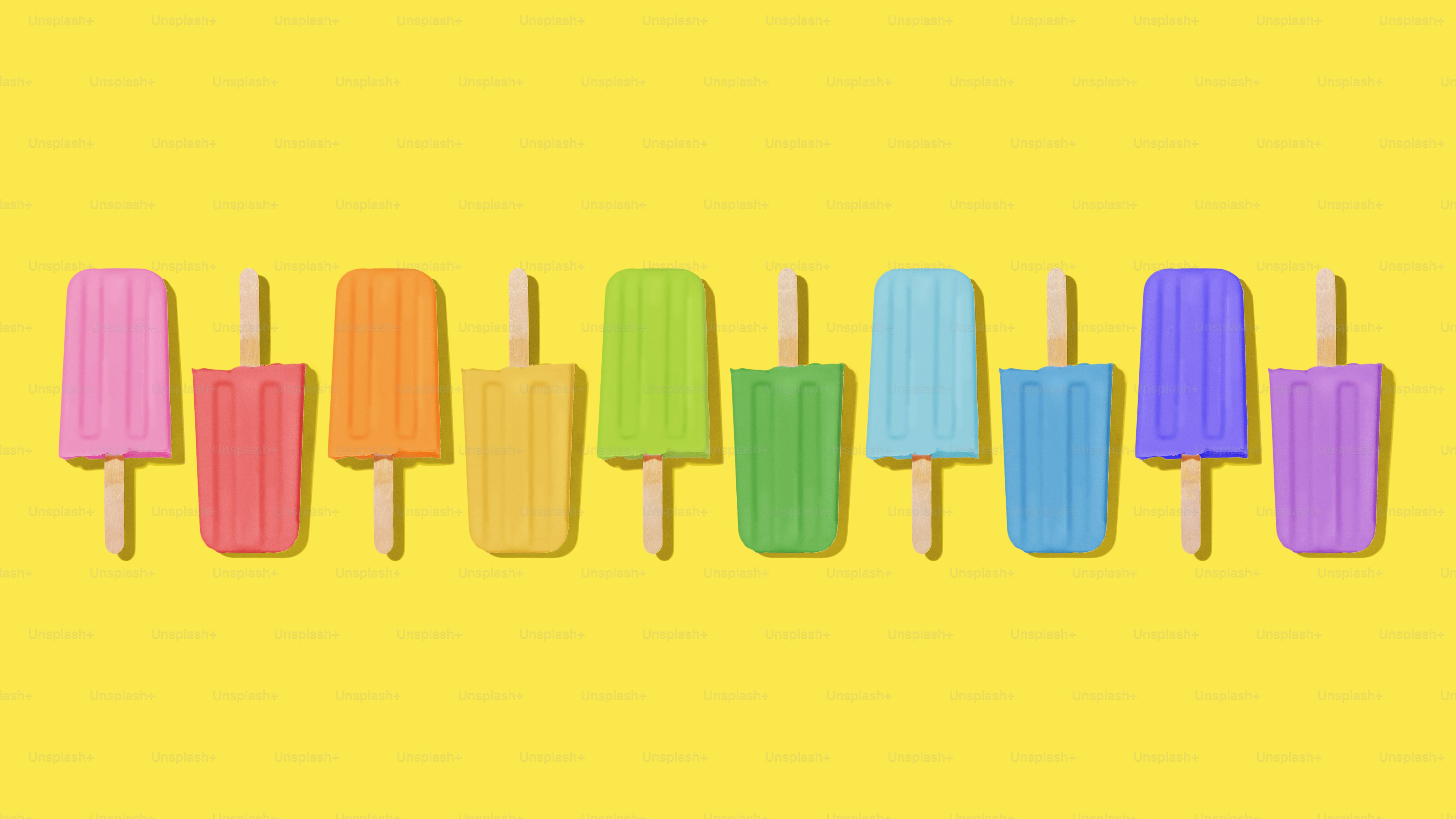 A row of popsicles sitting on top of each other photo – Popsicle Image ...