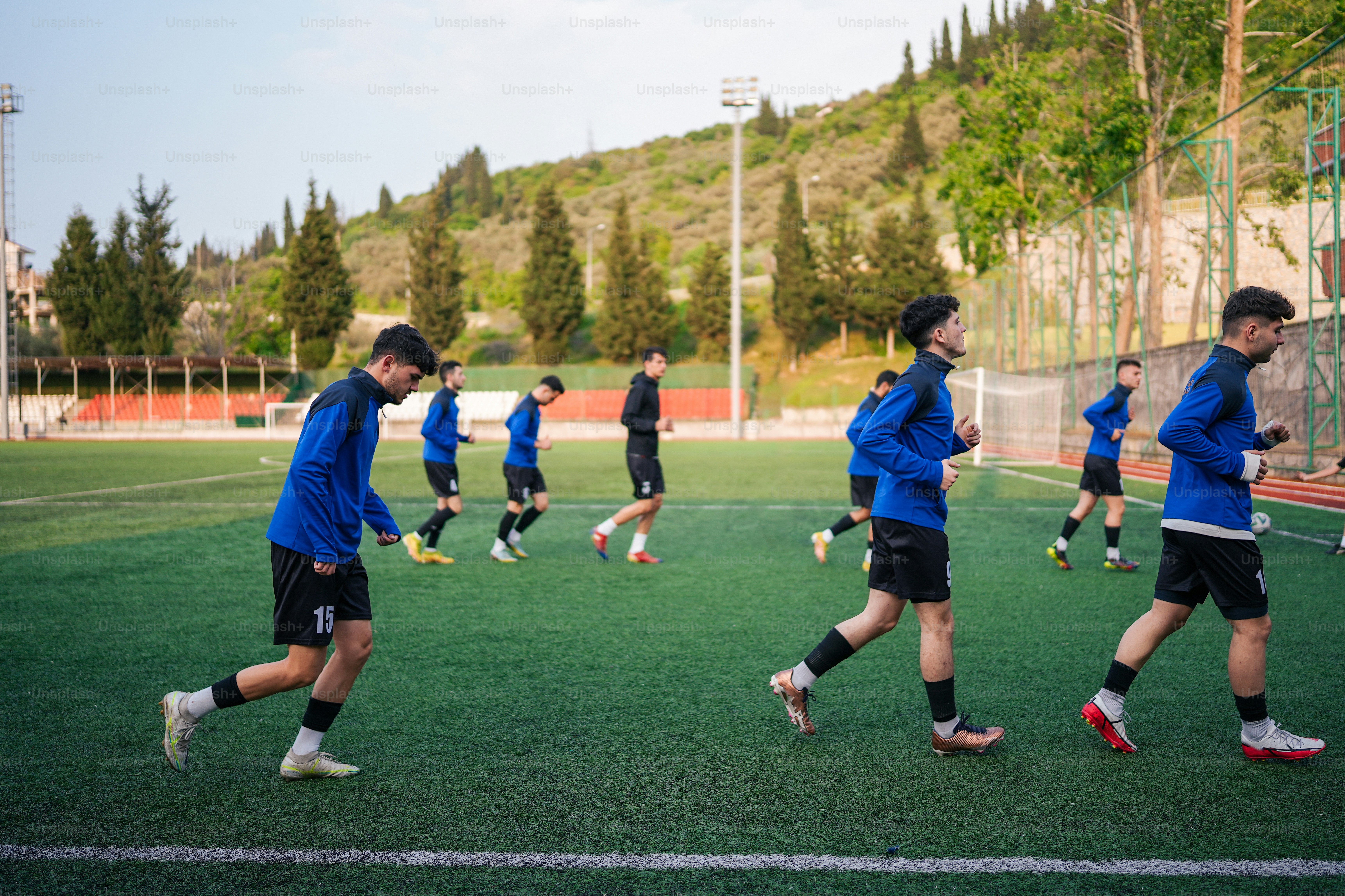 A group of young people playing a game of soccer photo – Teams Image on ...