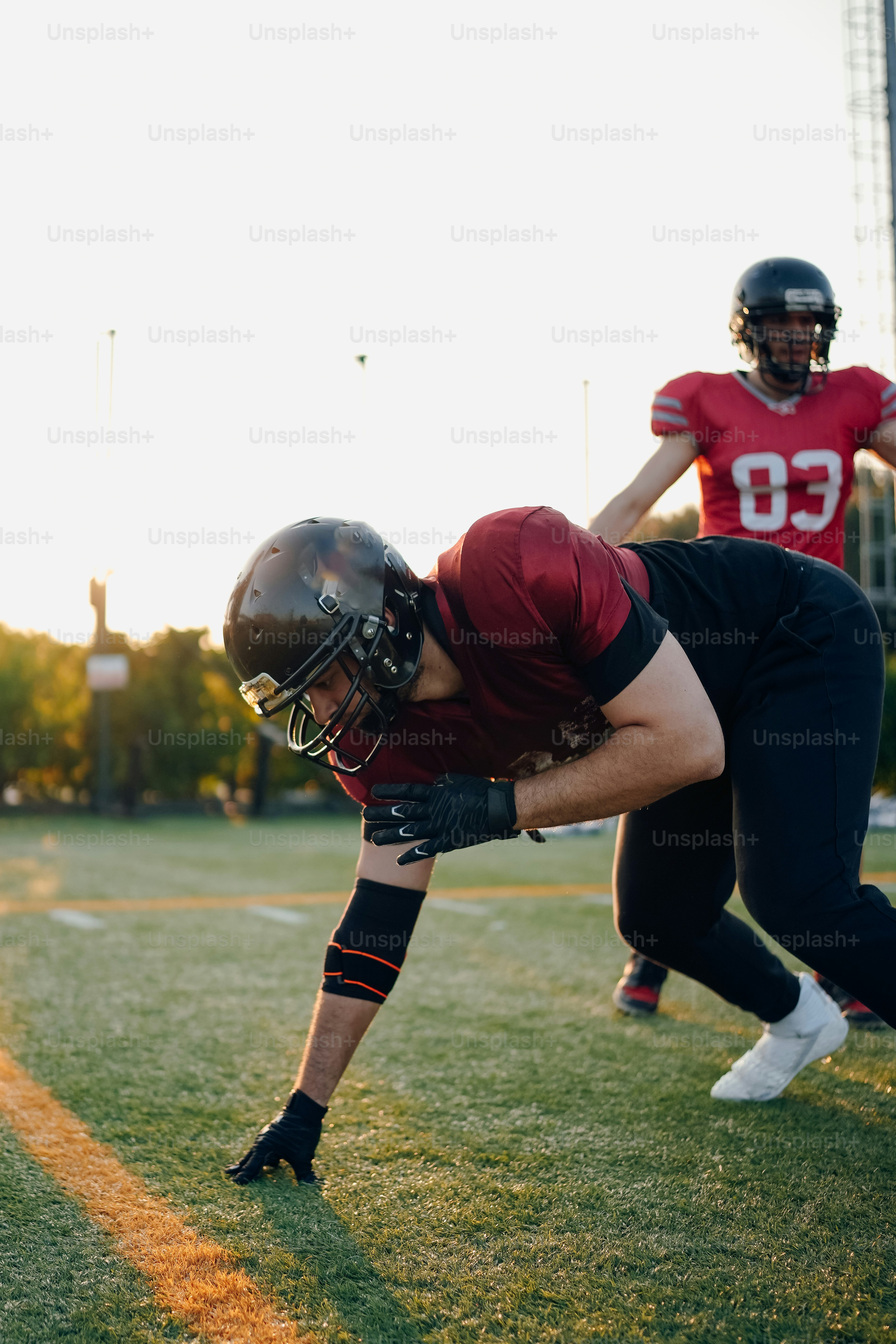 A football player holding a football and a helmet photo – American ...