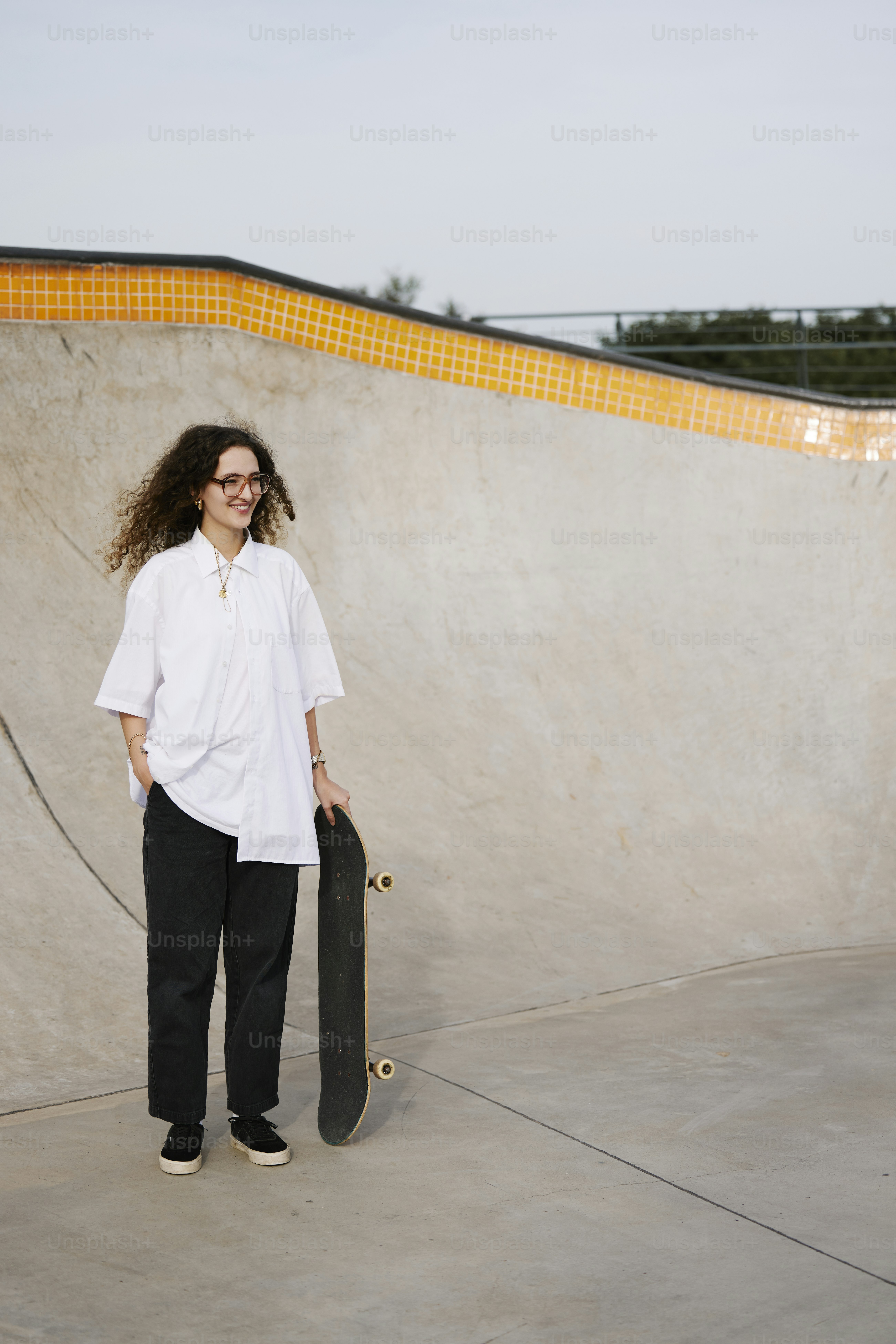 A person riding a skateboard at a skate park photo – Skateboarding ...