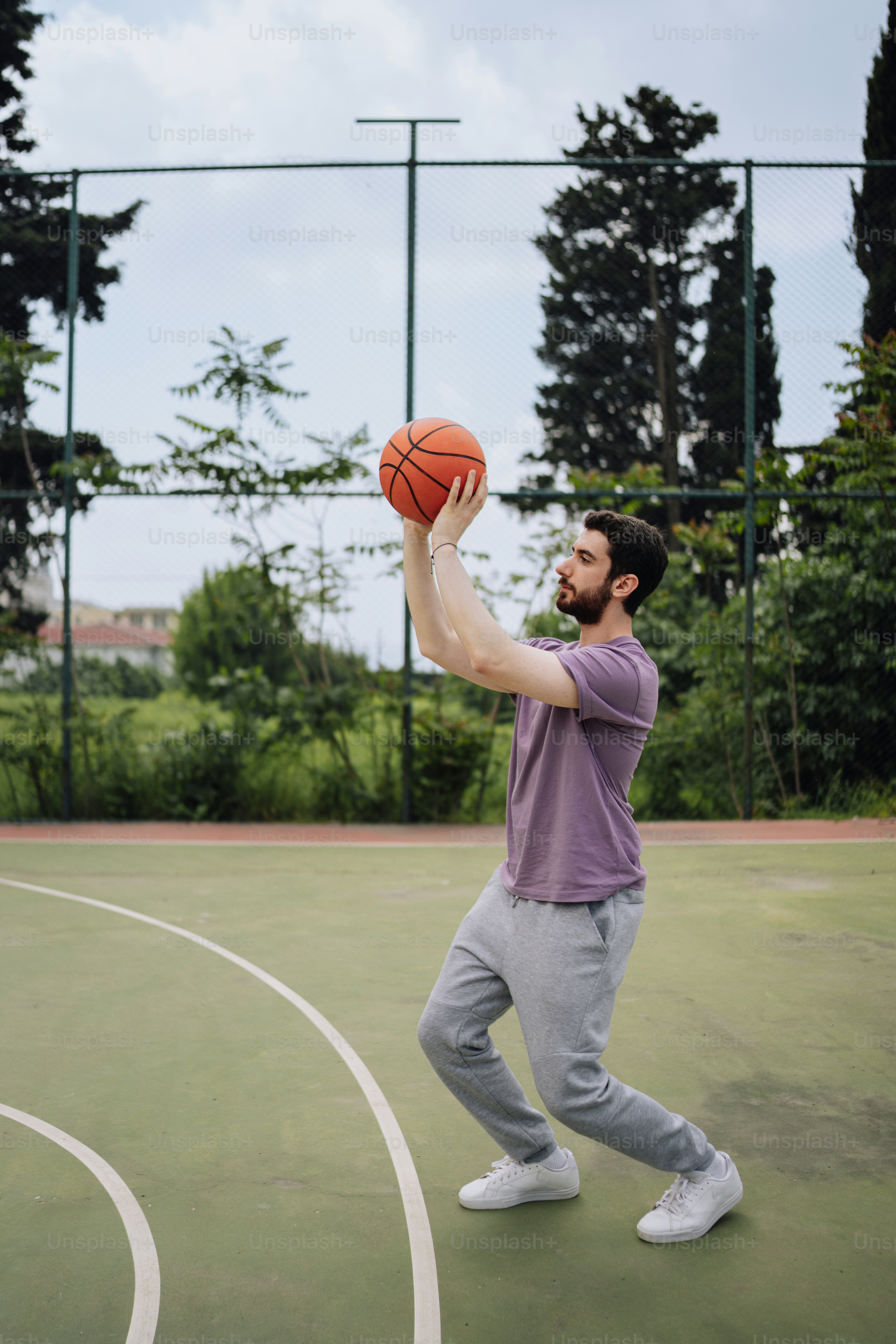 A person sitting on a court with a basketball photo – Sporting Image on ...