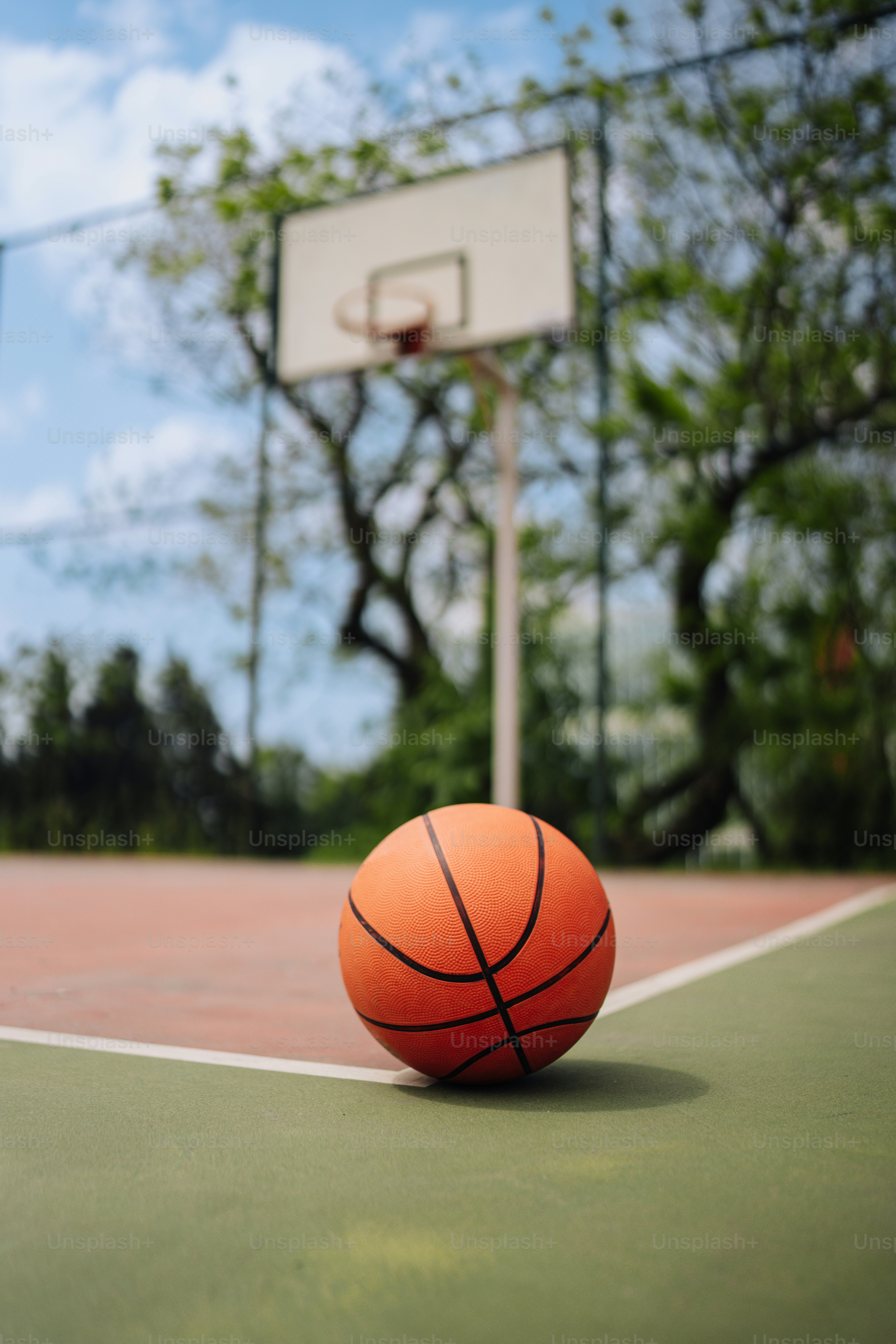 A person sitting on a court with a basketball photo – Sporting Image on ...