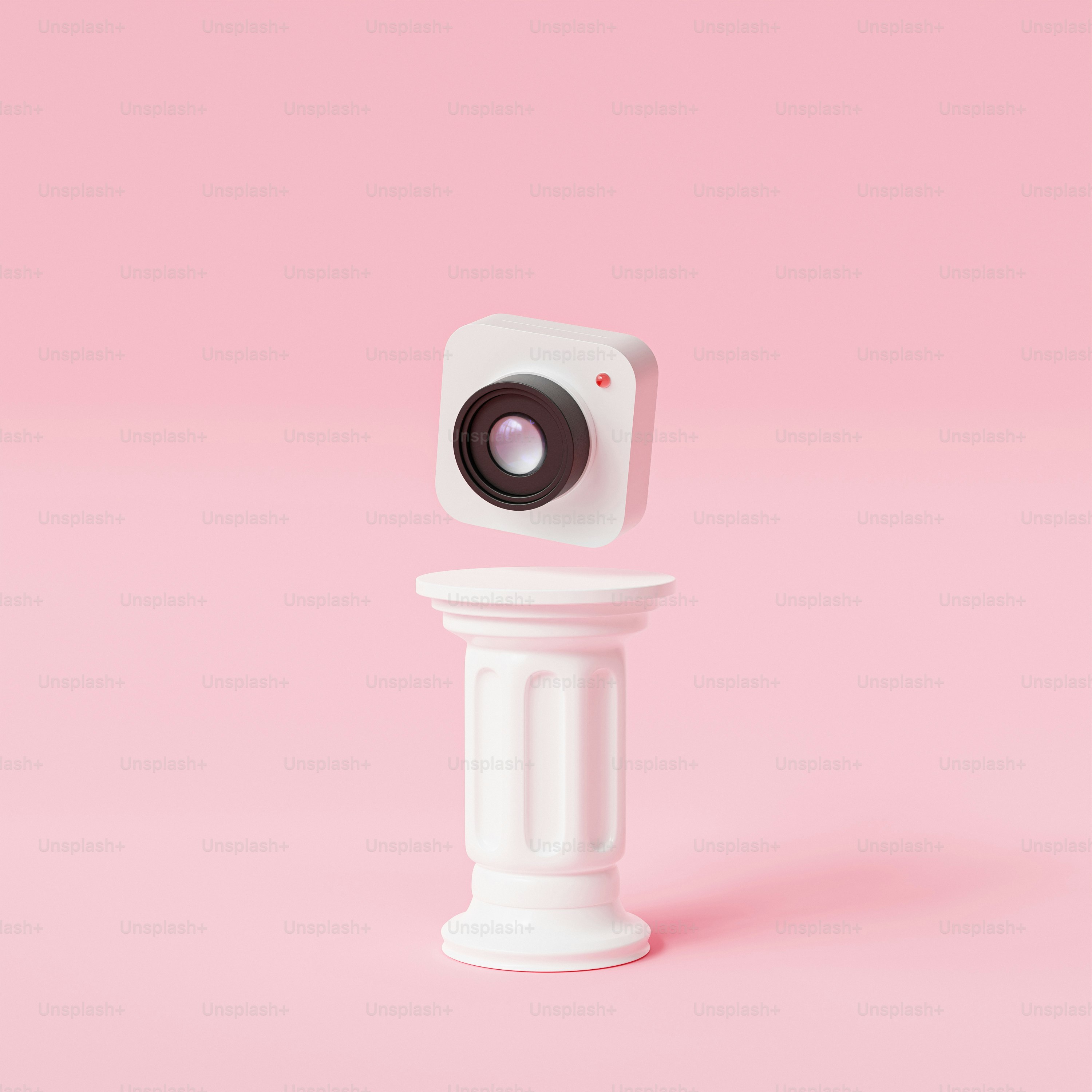 A small camera sitting on top of a white pedestal photo – Social media ...