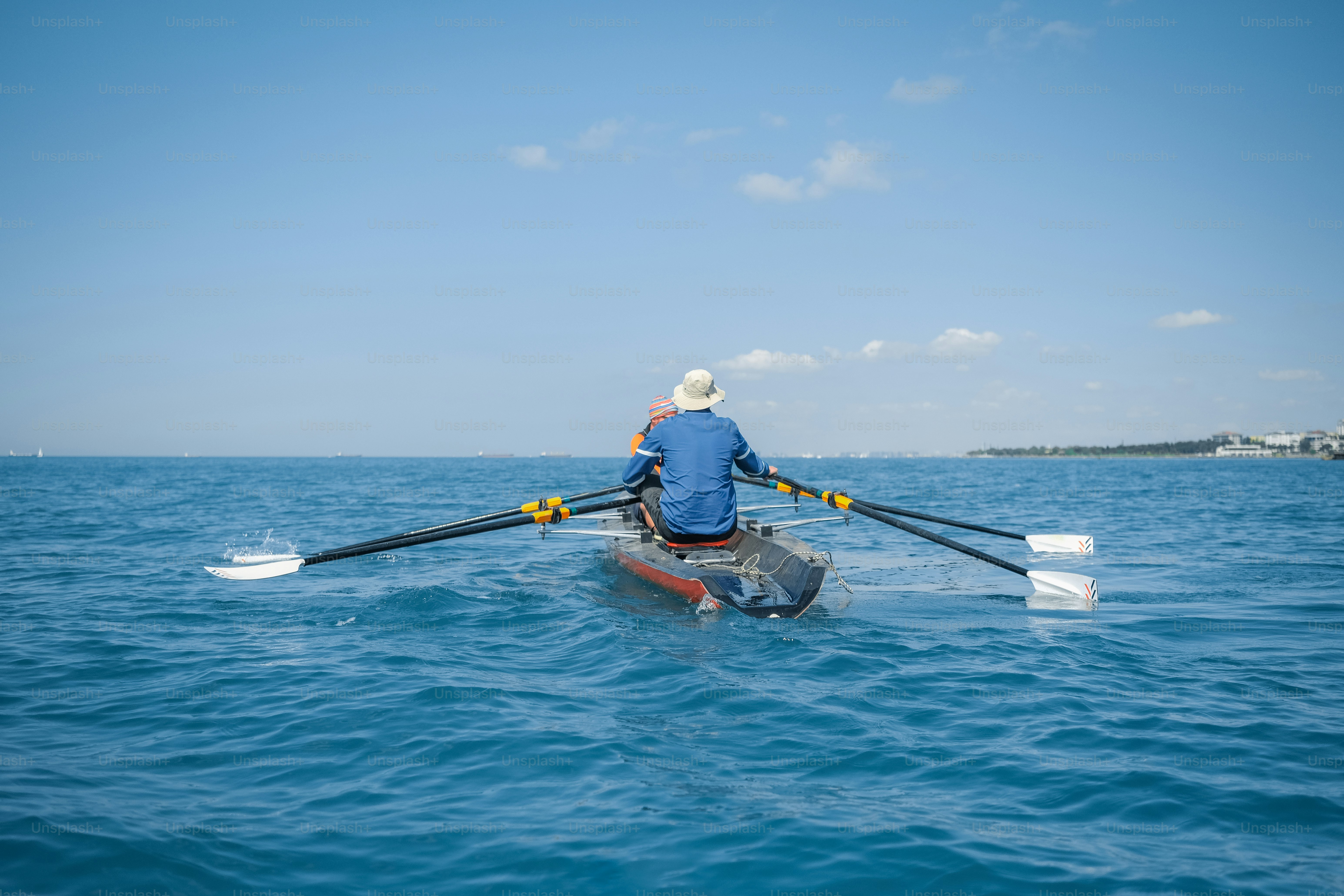 A man rowing a boat in the ocean photo – Row Image on Unsplash