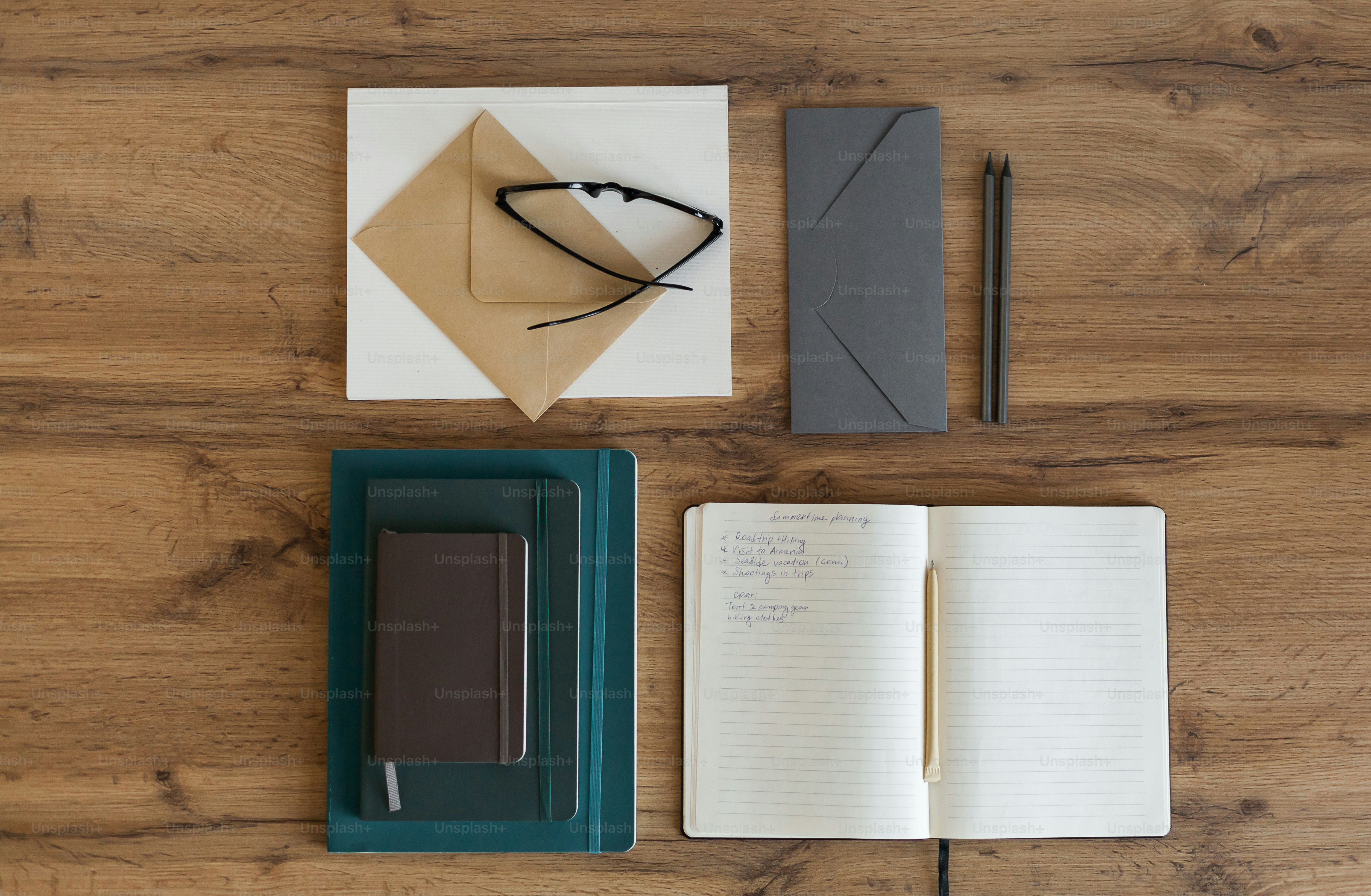 A notepad, pen, notebook, and paper on a wooden table photo – Desk ...
