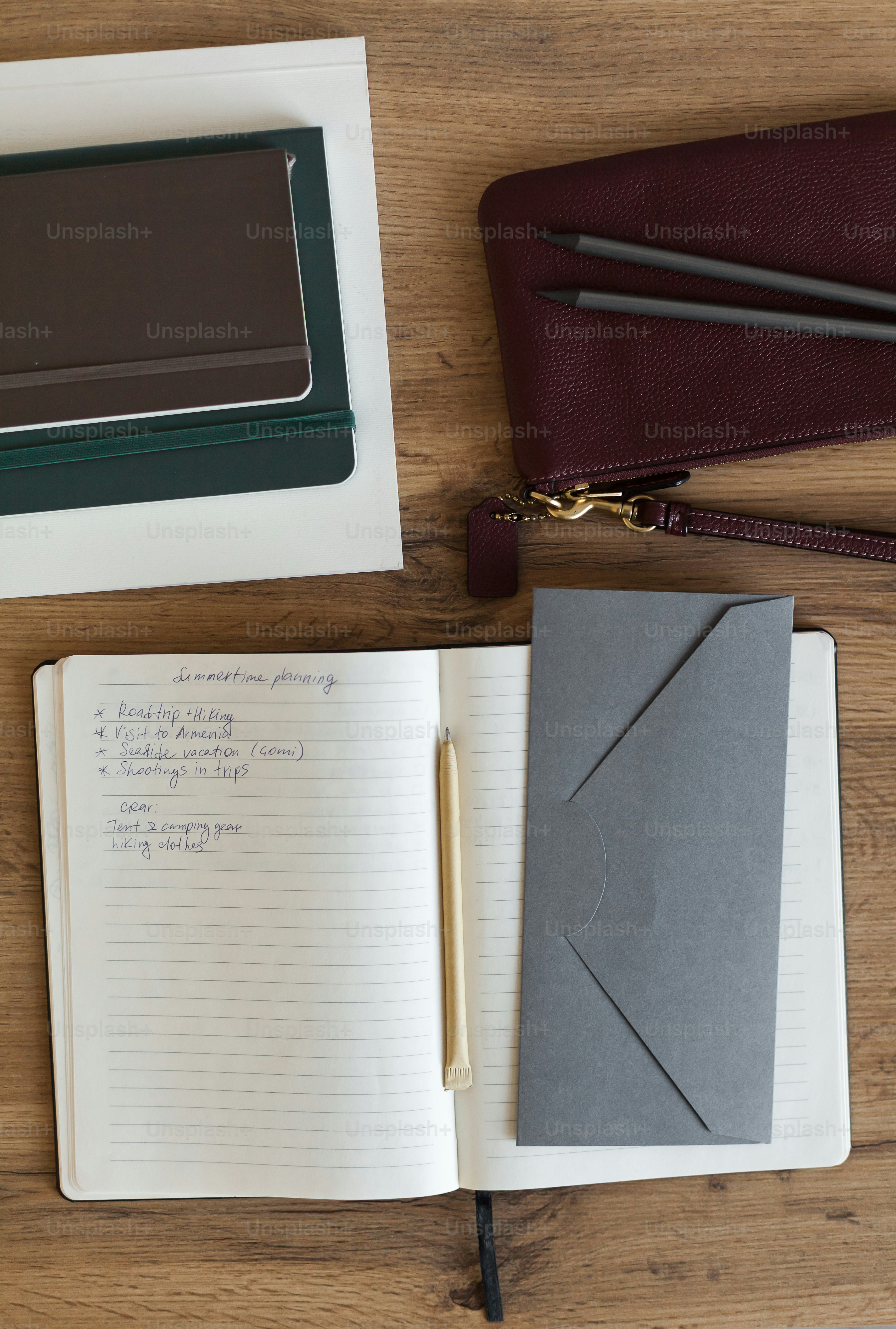 A notebook with a pen and a notepad on a table photo – Desk Image on ...