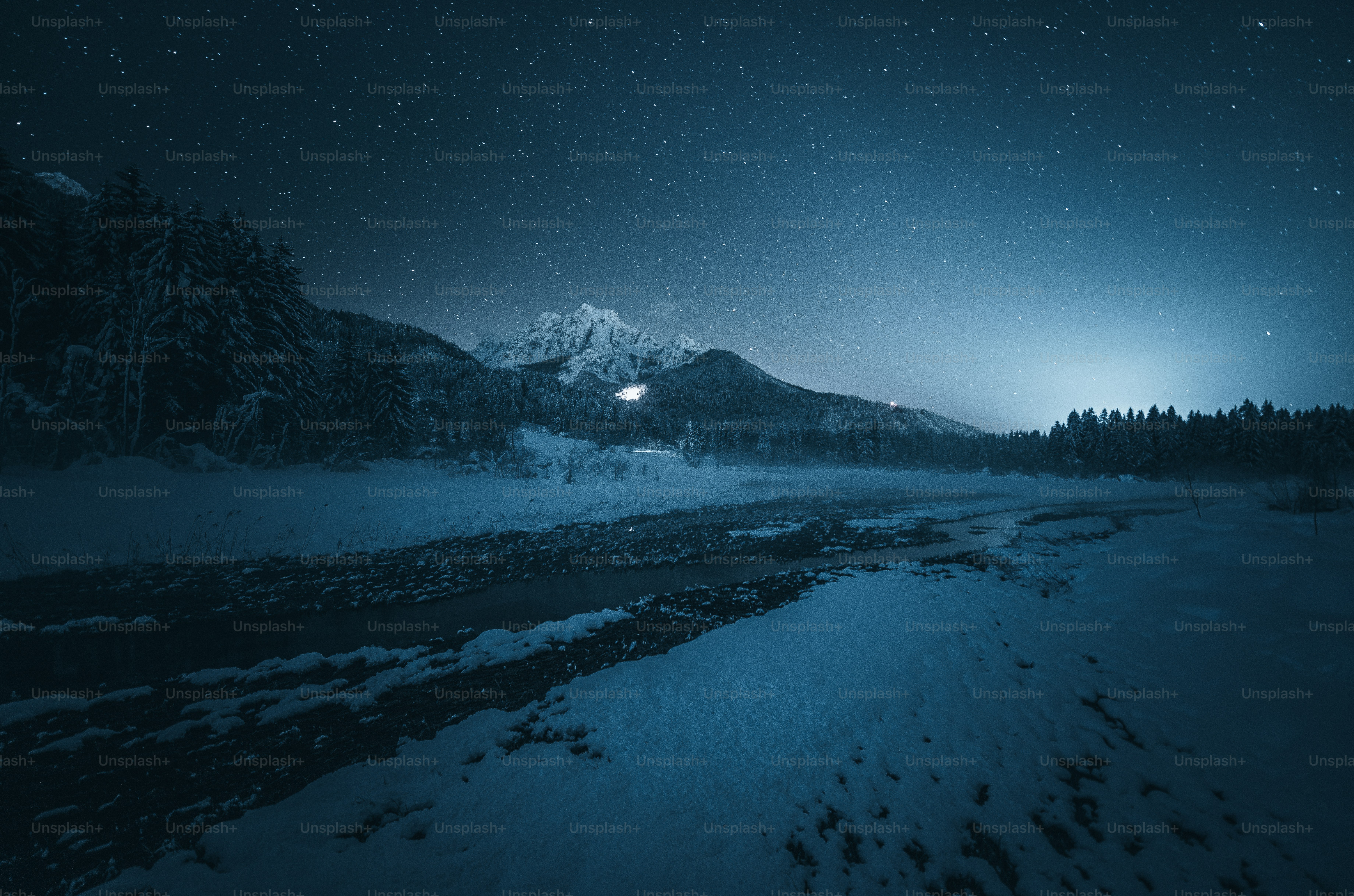 A snowy path leading to a mountain at night photo – Wallpaper Image on ...