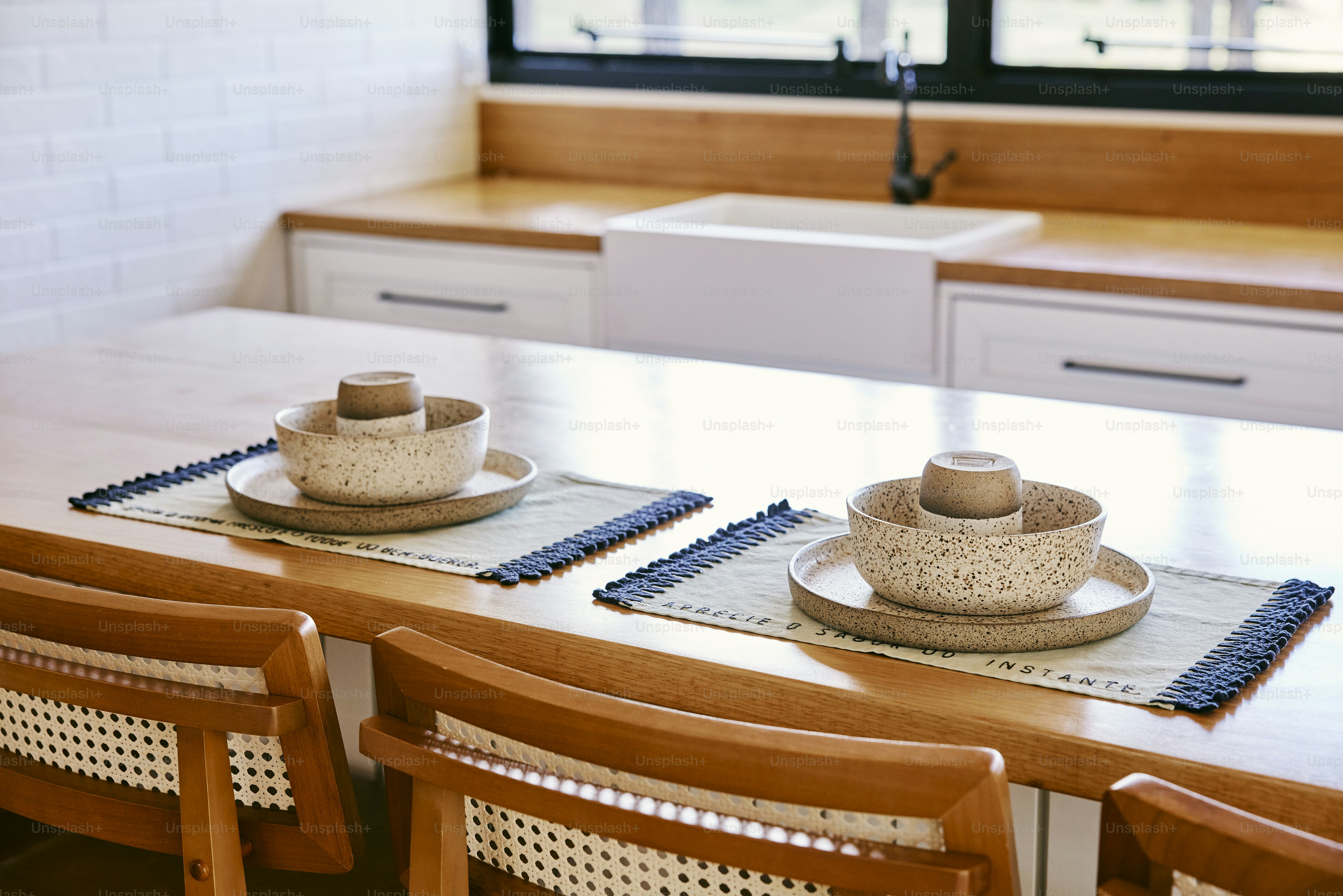 A wooden table with two bowls and two plates on it photo – House Image ...
