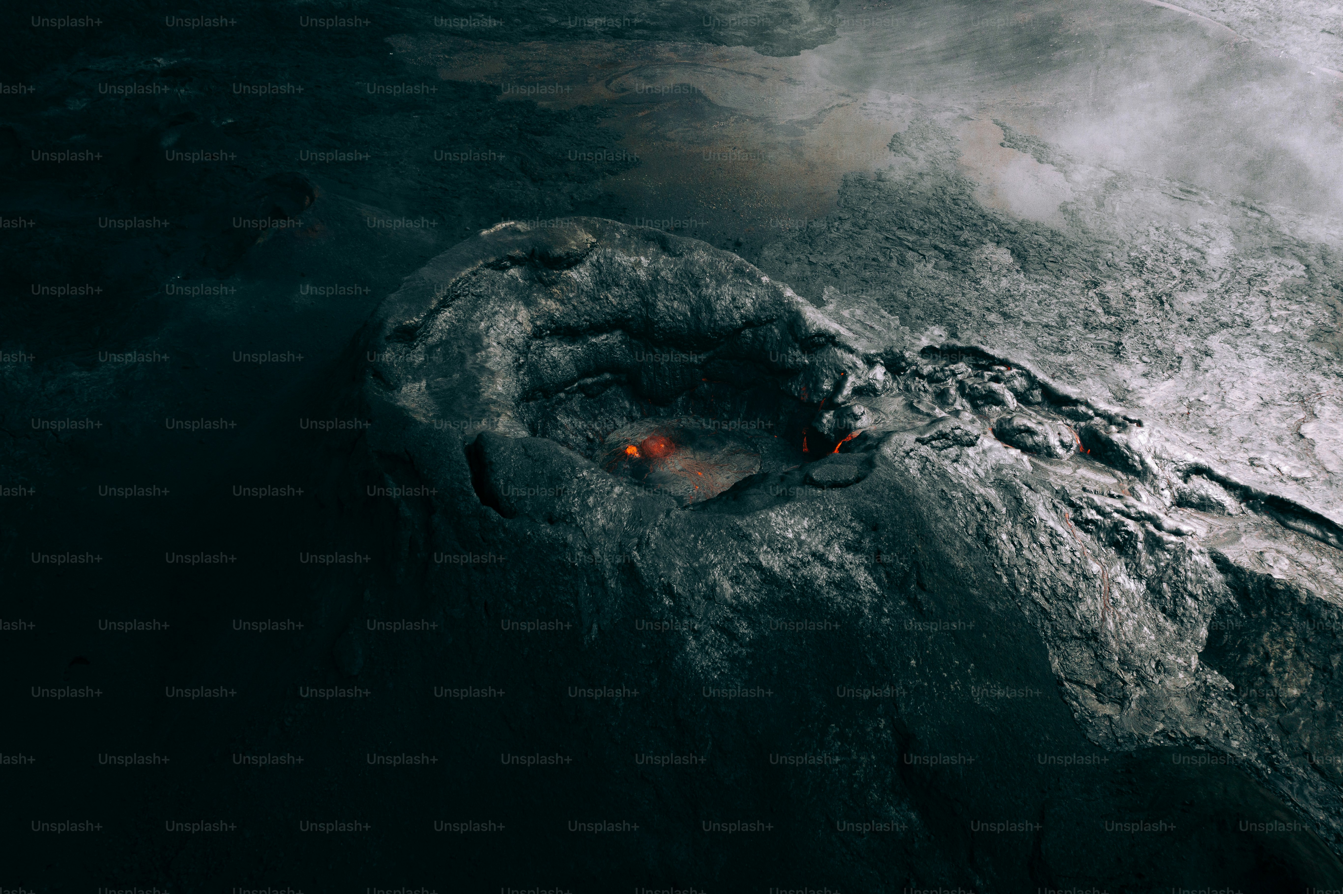 An aerial view of a lava volcano in the ocean photo – Volcano Image on ...