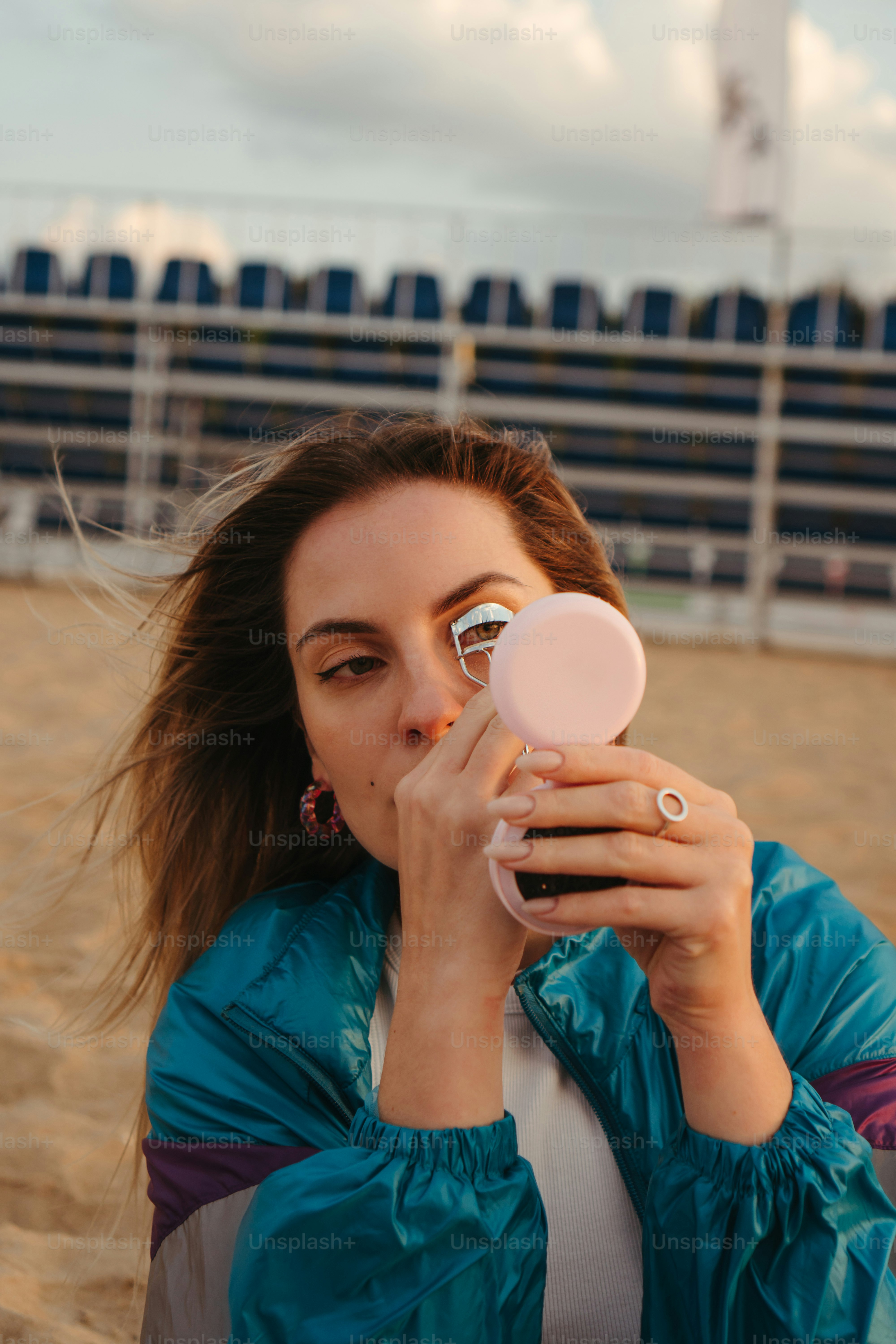 A woman holding a compact compact compact compact compact compact ...
