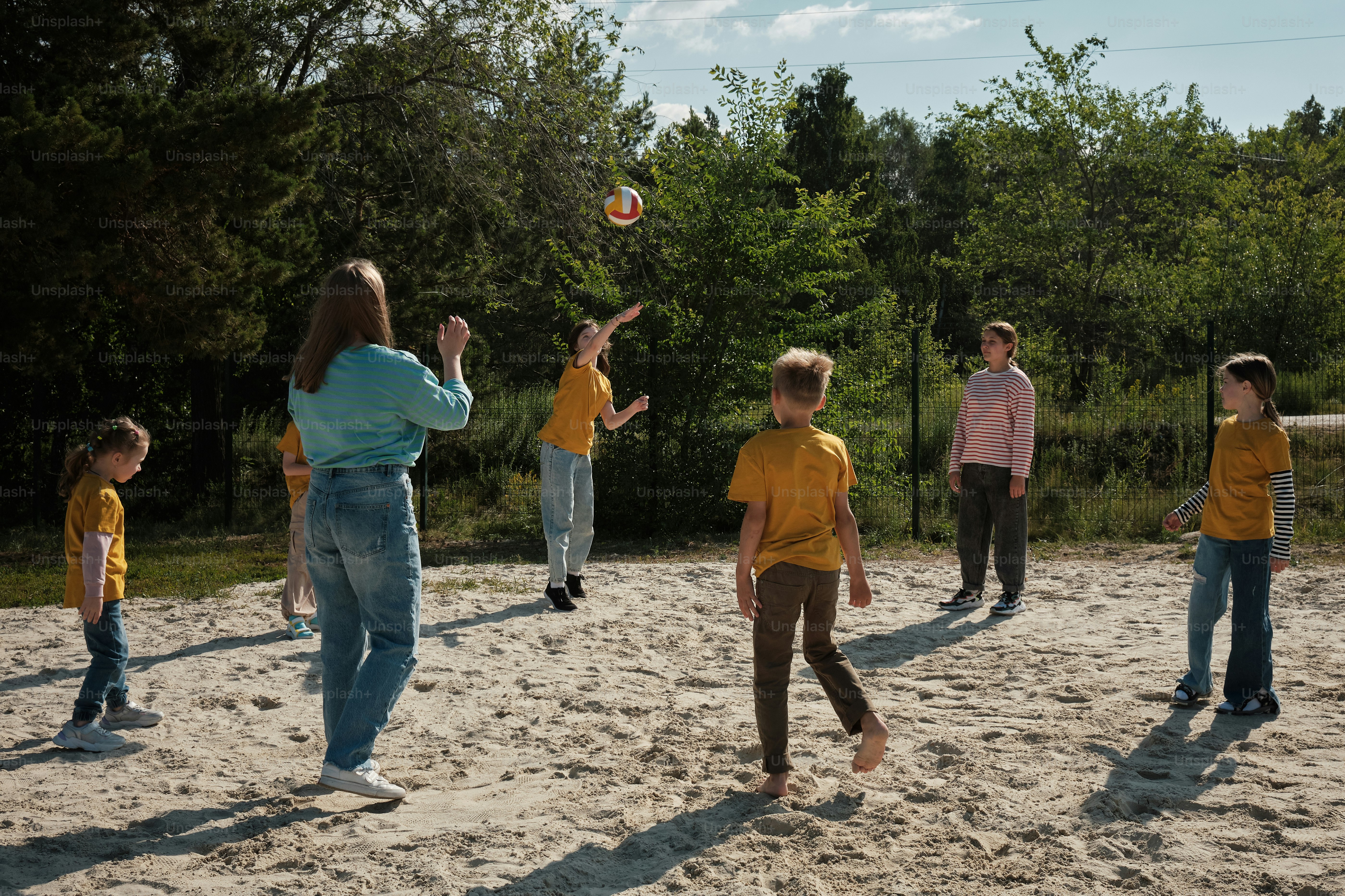A group of young children playing a game of badminton photo – Adventure ...