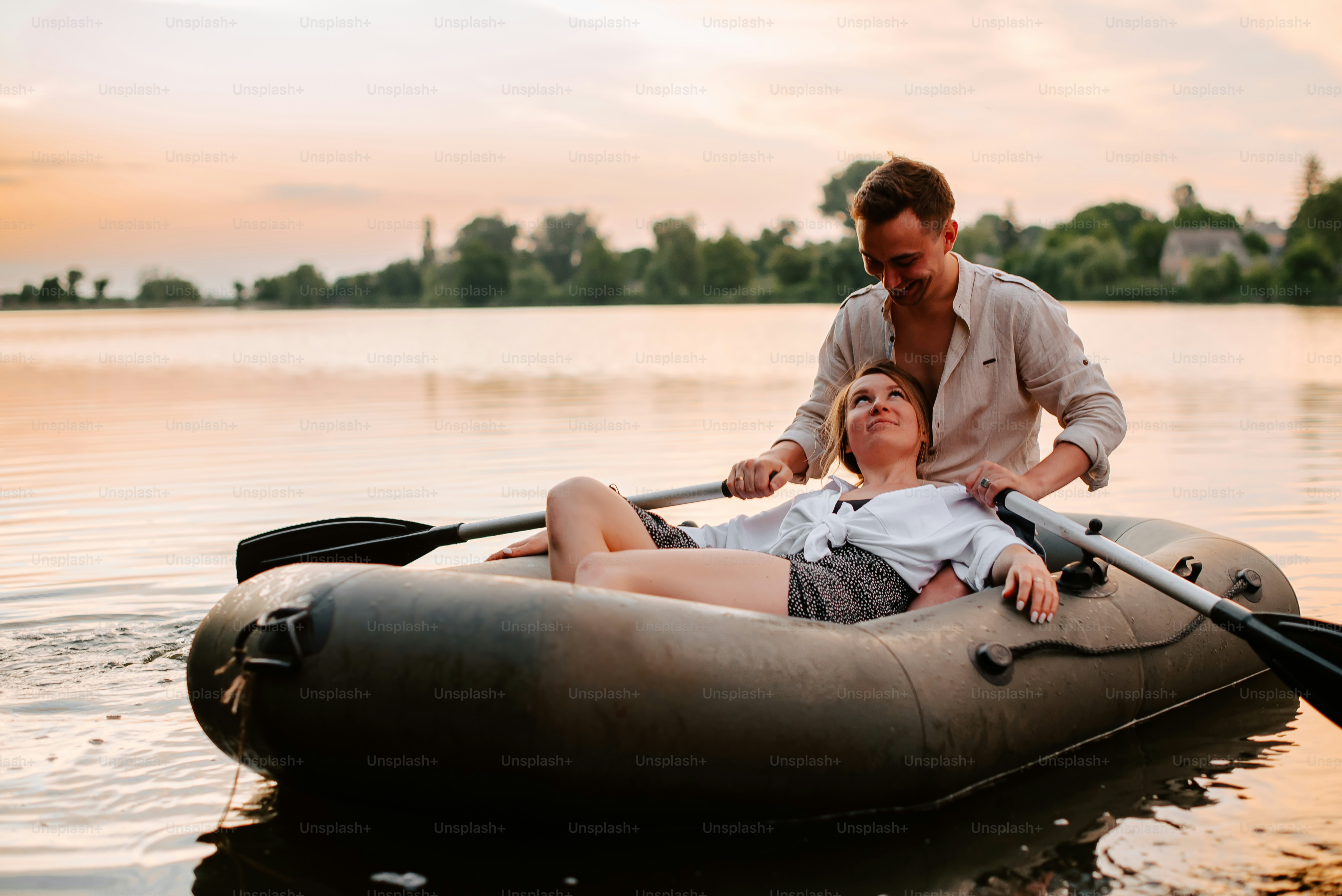 A man and a woman on a raft in the water photo – Romantic couple Image ...