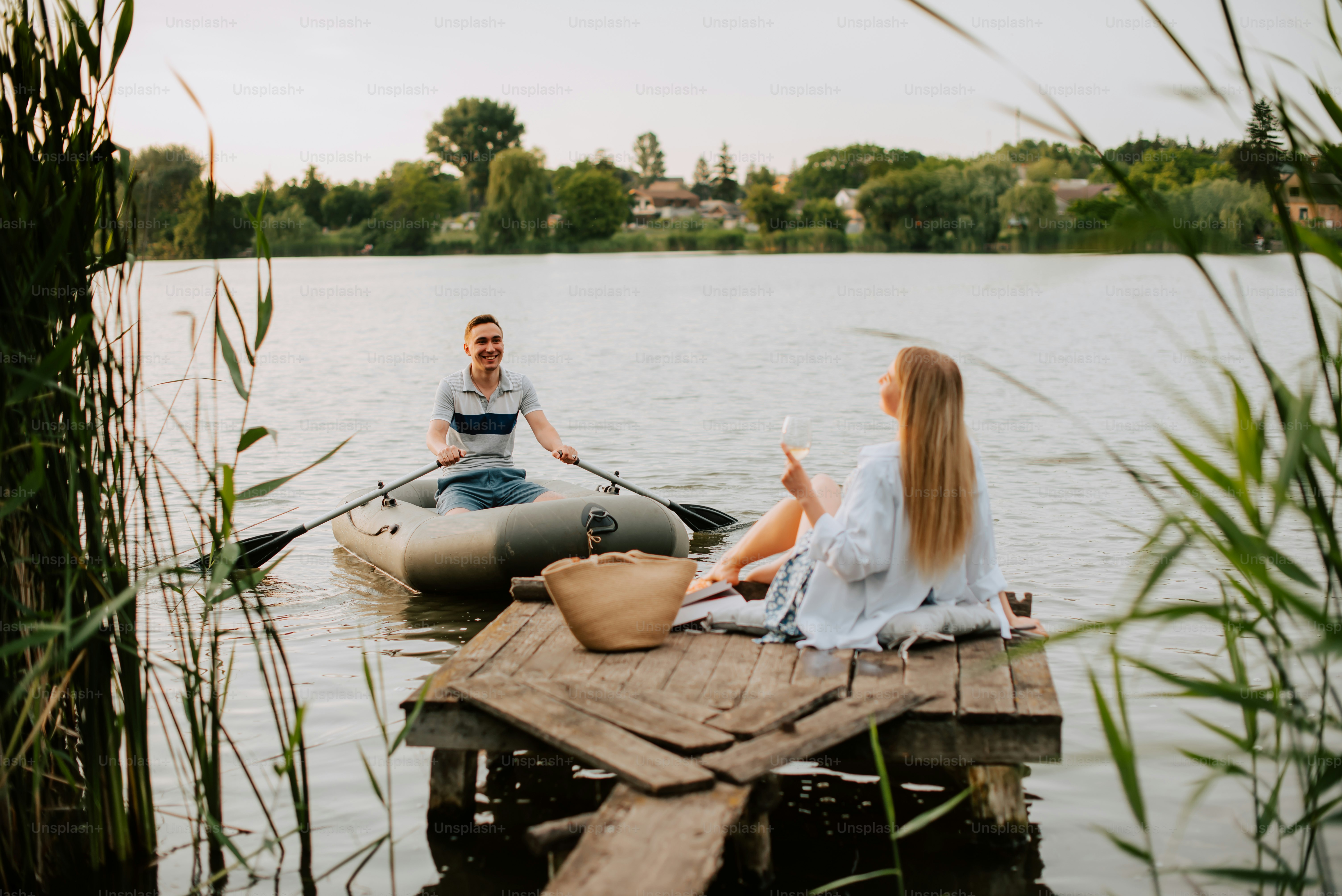 A man and a woman on a raft in the water photo – Love one another Image ...