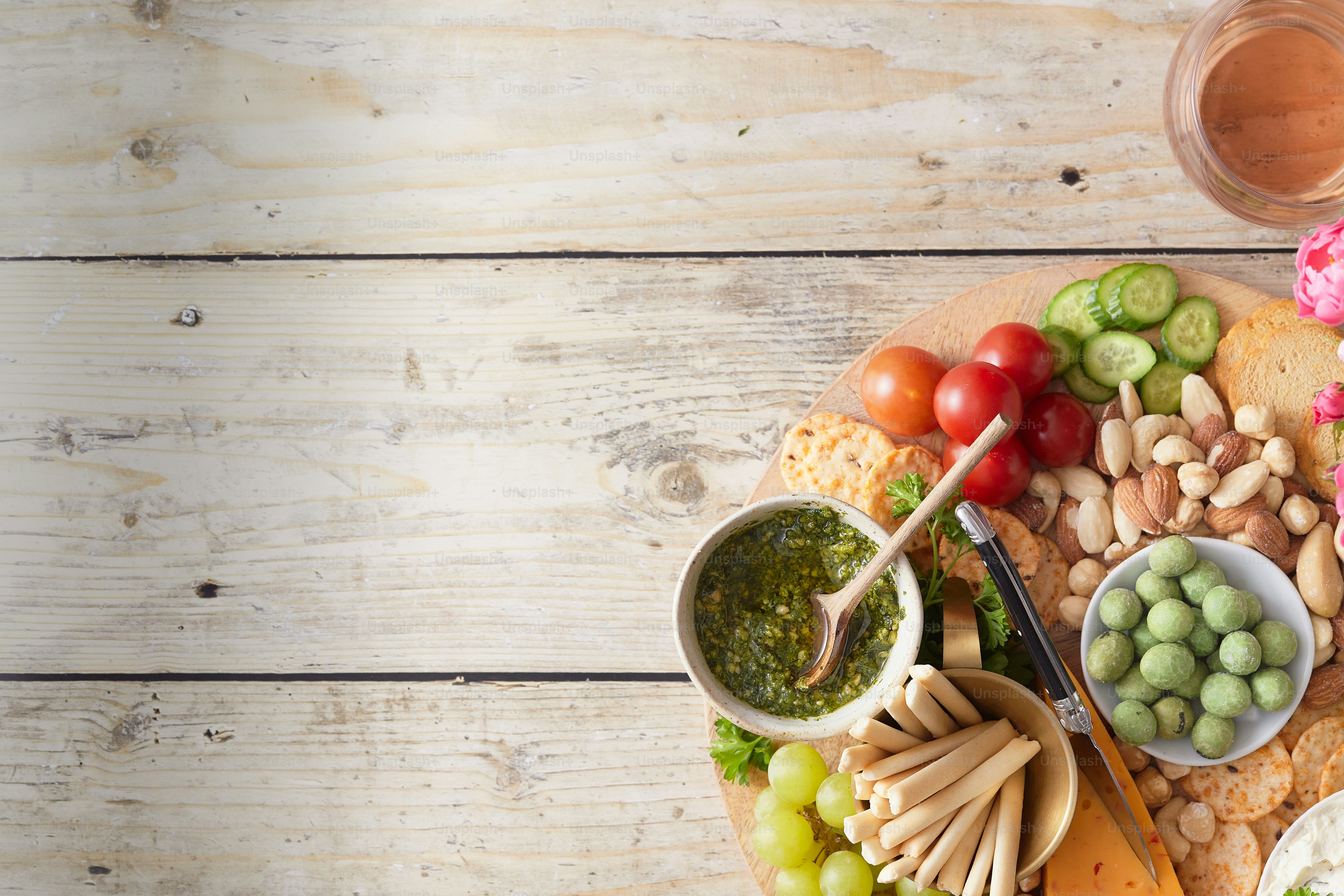 A platter of cheese, crackers, nuts, and vegetables photo – Snacks ...