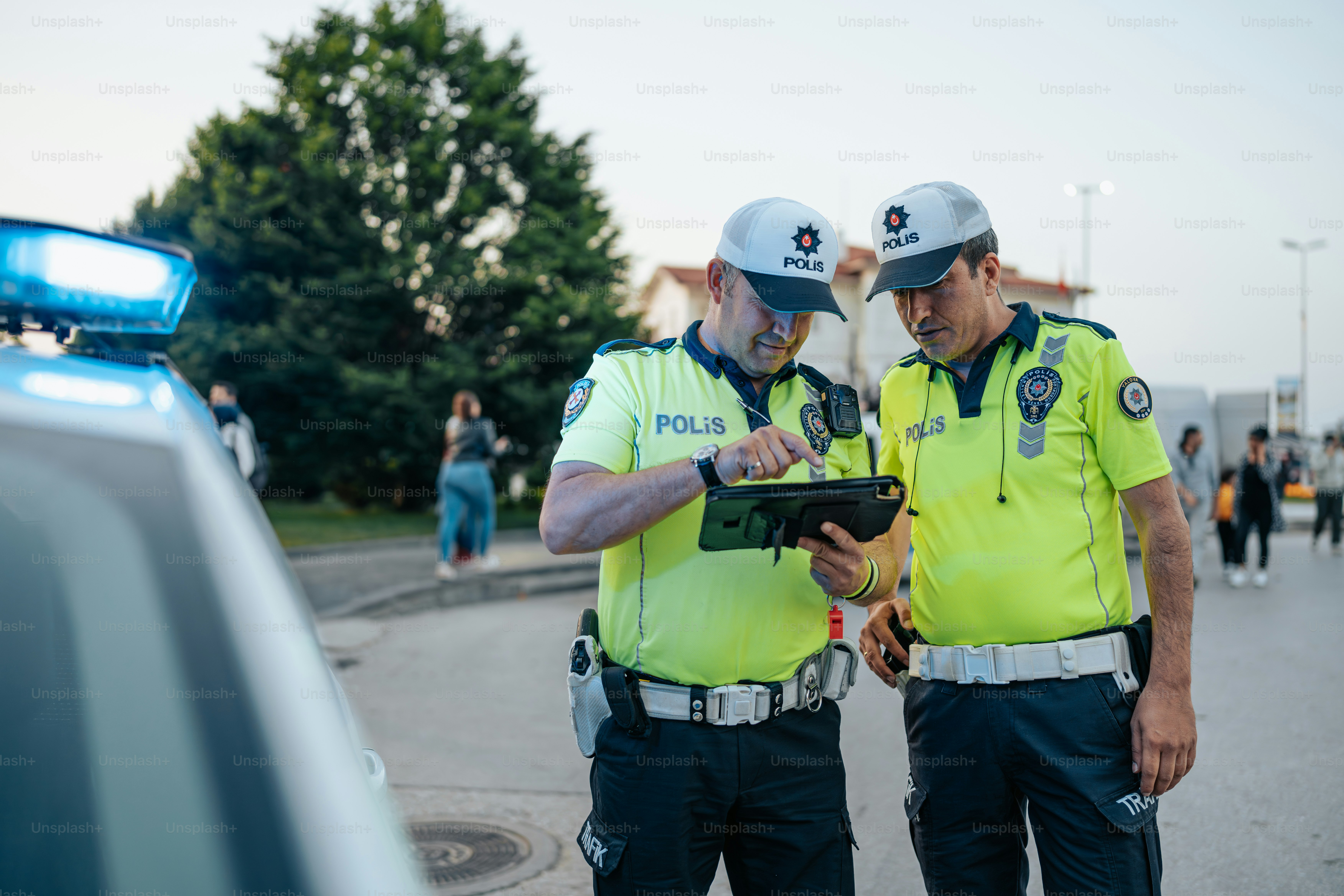 Two police officers standing next to each other photo – Police Image on ...