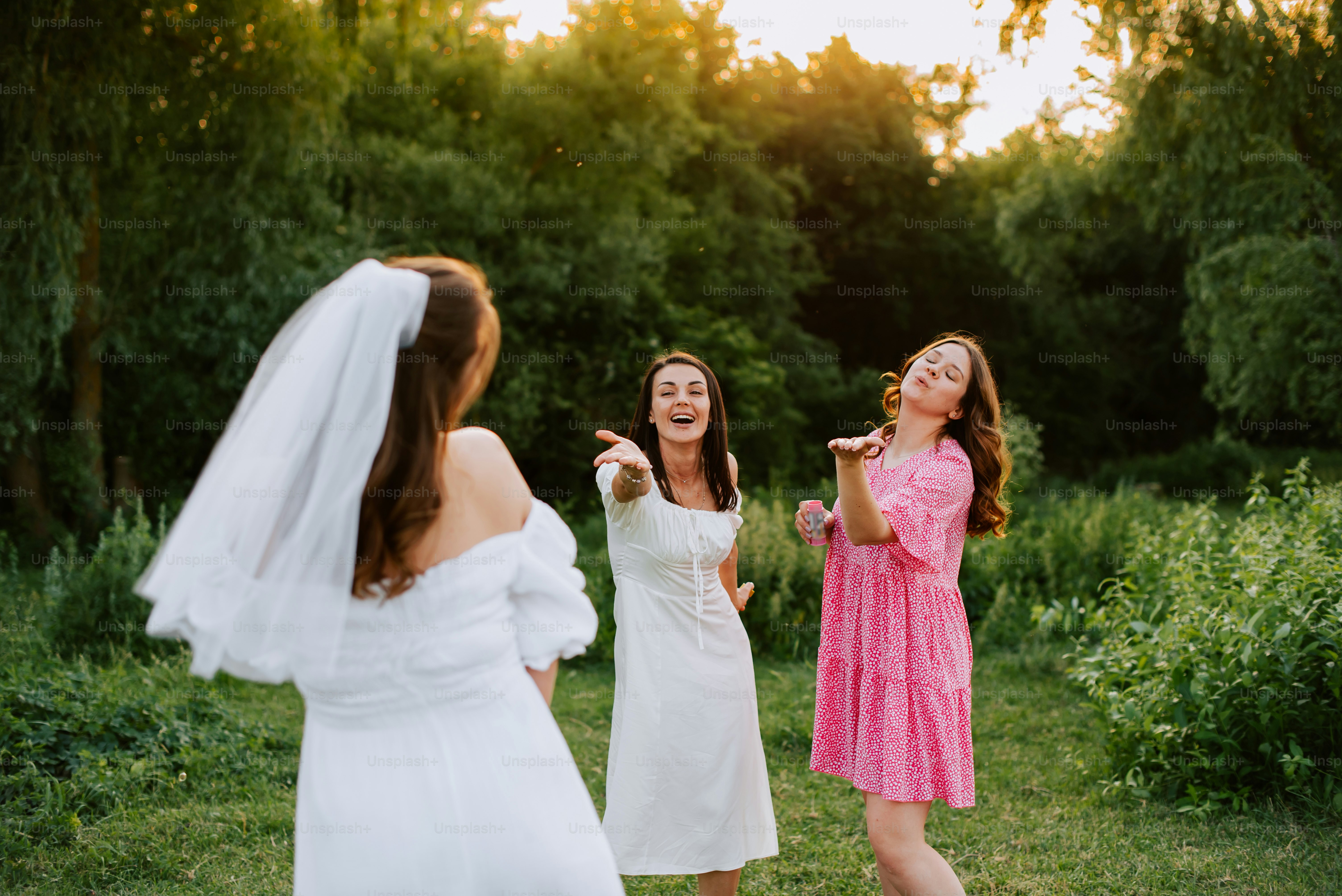 A bride and her bridesmaids are laughing together photo – Bride Image ...