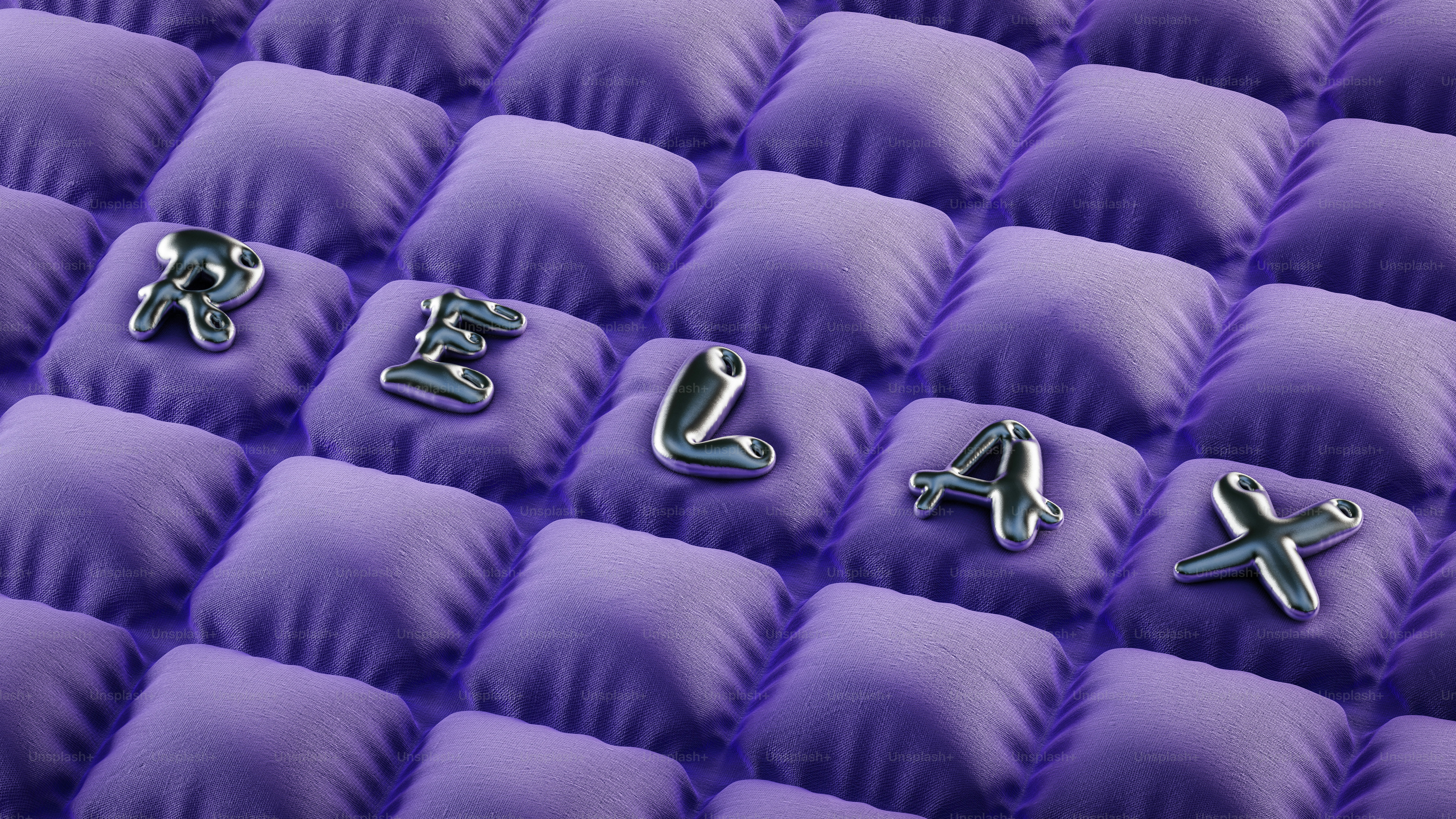 A group of metal letters sitting on top of a purple couch photo ...