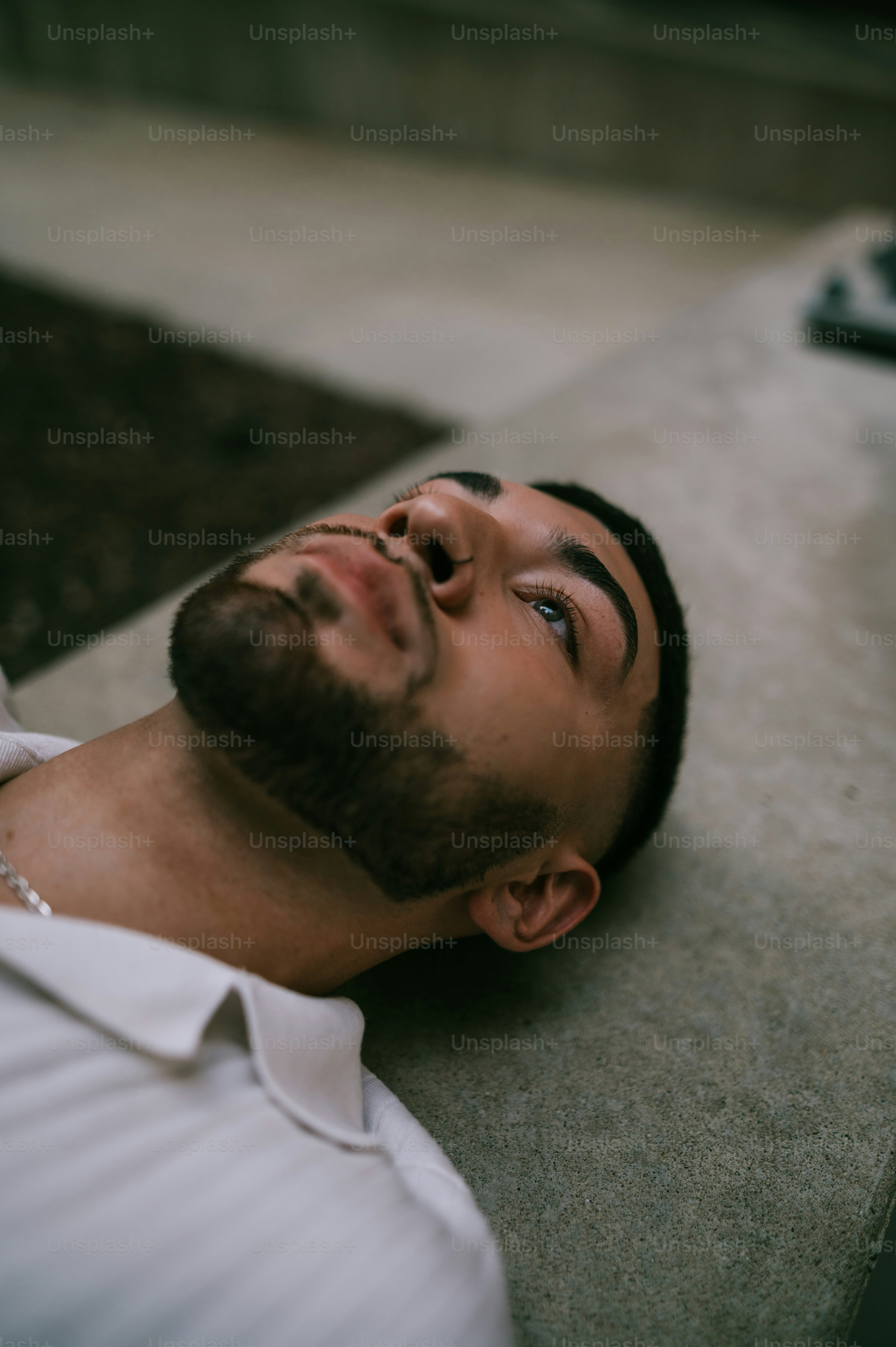 A man laying down on a concrete ledge photo – Gen z teenagers Image on ...