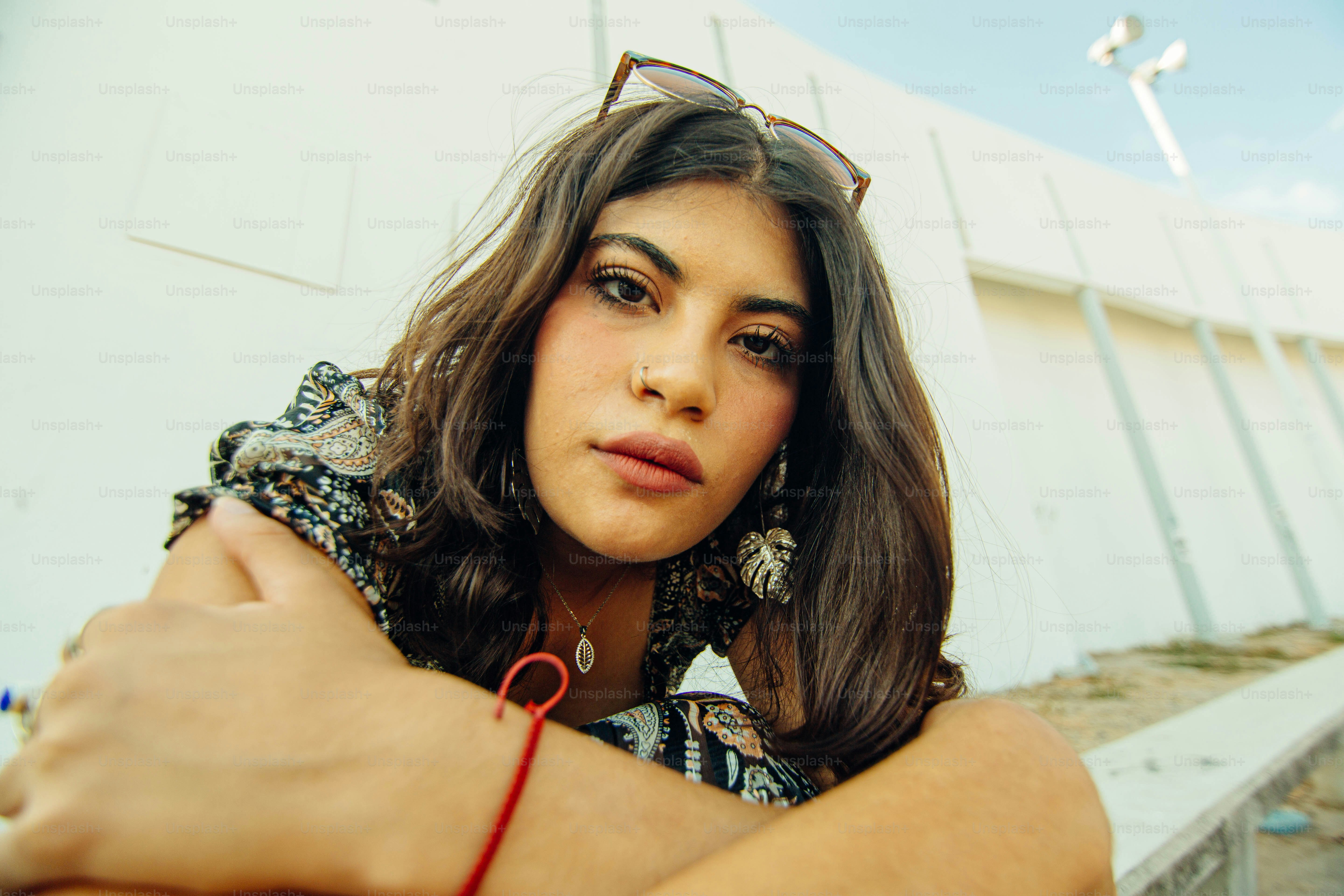 A woman with a red string around her neck photo – Gen z Image on Unsplash