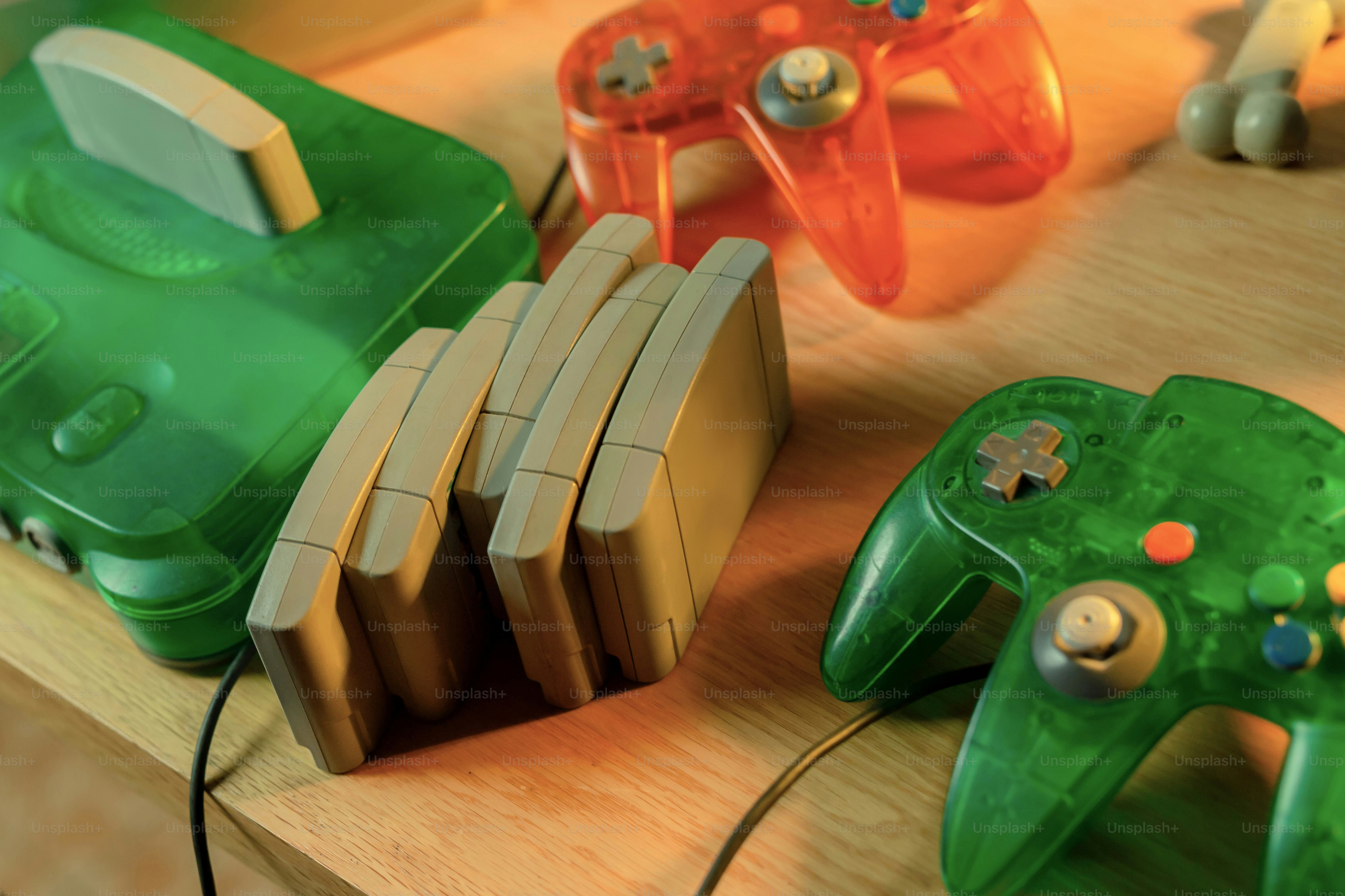 A couple of video game controllers sitting on top of a table photo ...