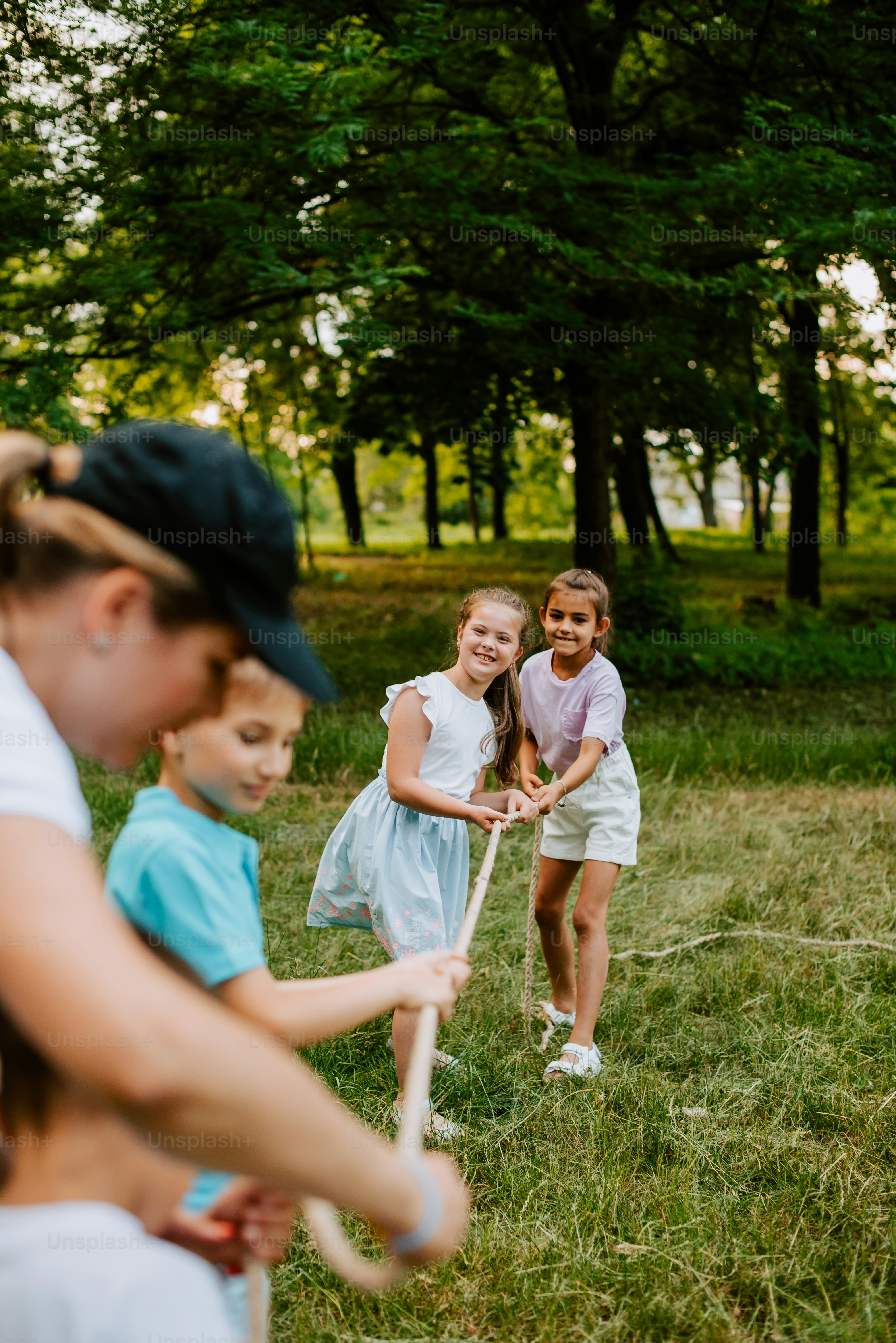 A group of young children playing a game of baseball photo – Summer ...