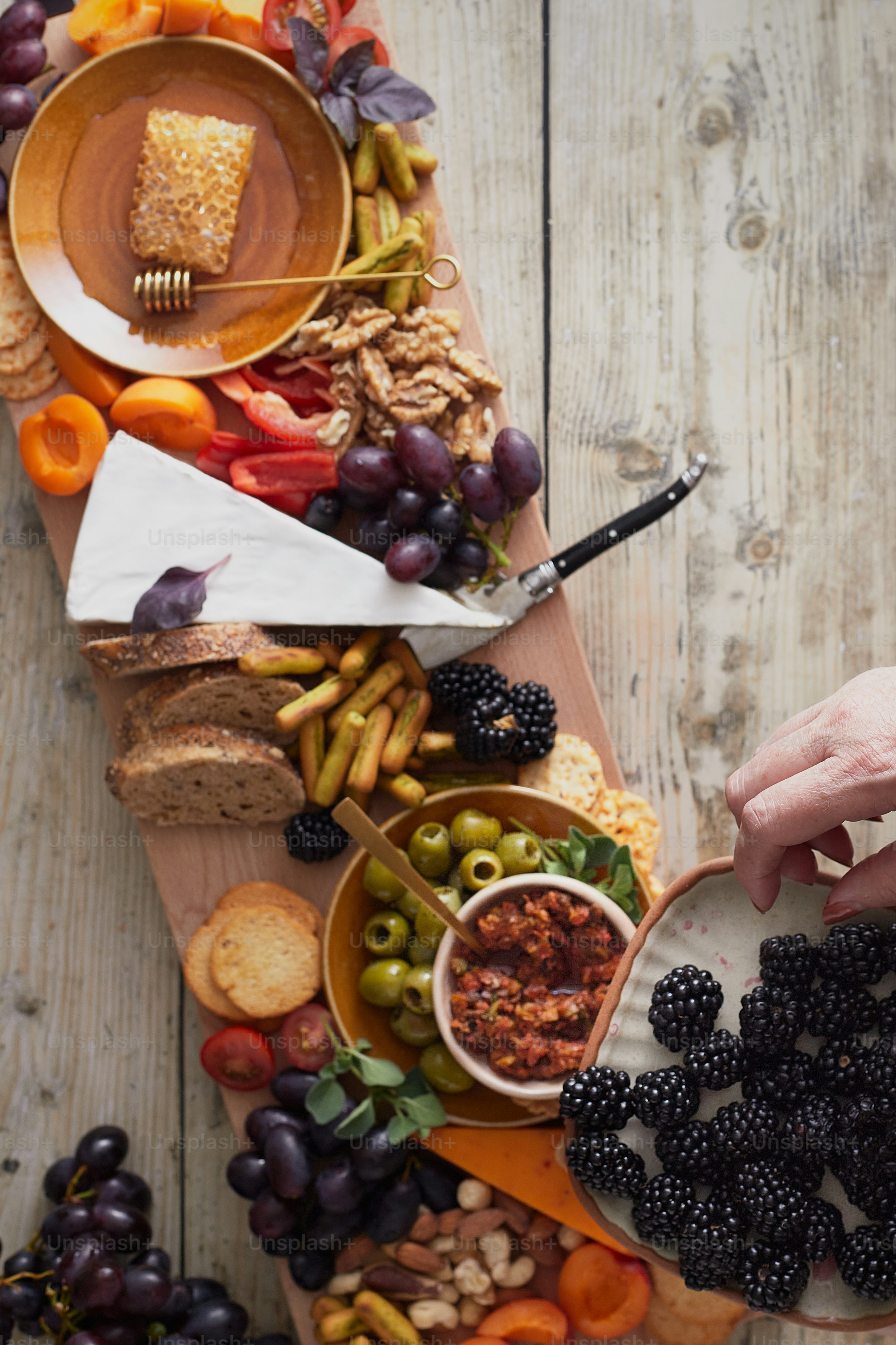 A wooden table topped with a platter of food photo – Nuts Image on Unsplash