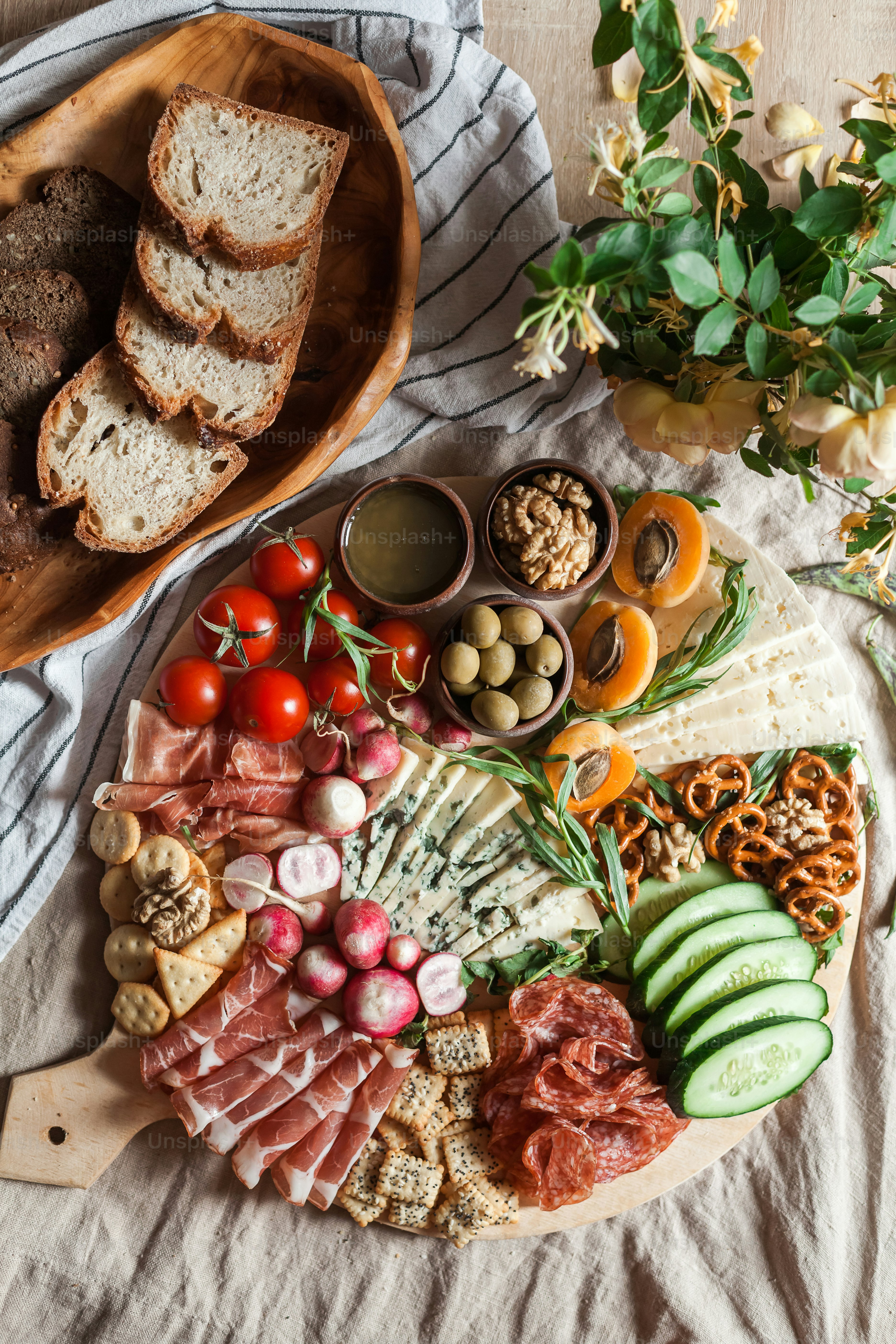 A platter of meats, cheeses, breads, and vegetables photo – Bread Image ...