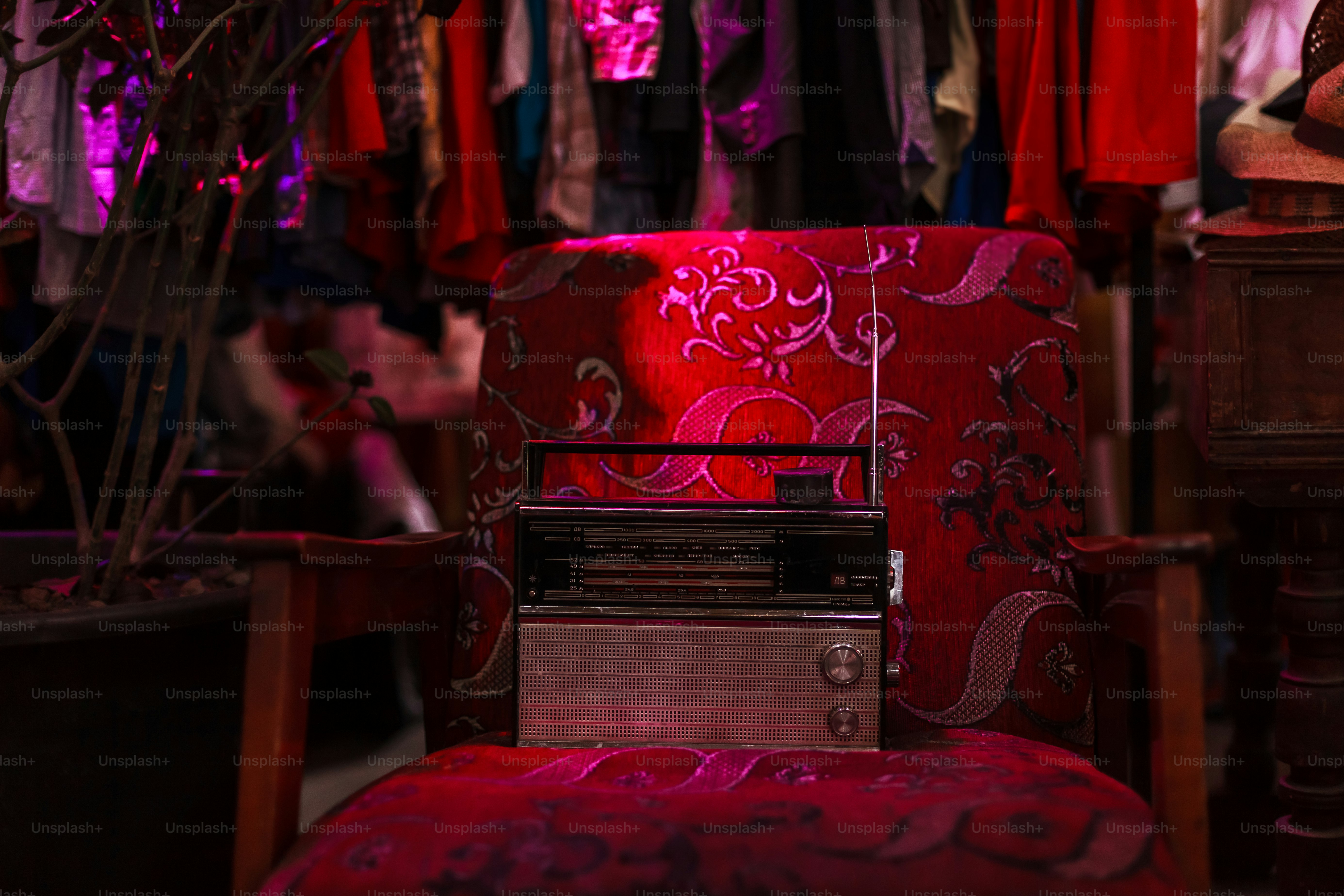 A radio sitting on a red chair in a room photo – Old radio Image on ...