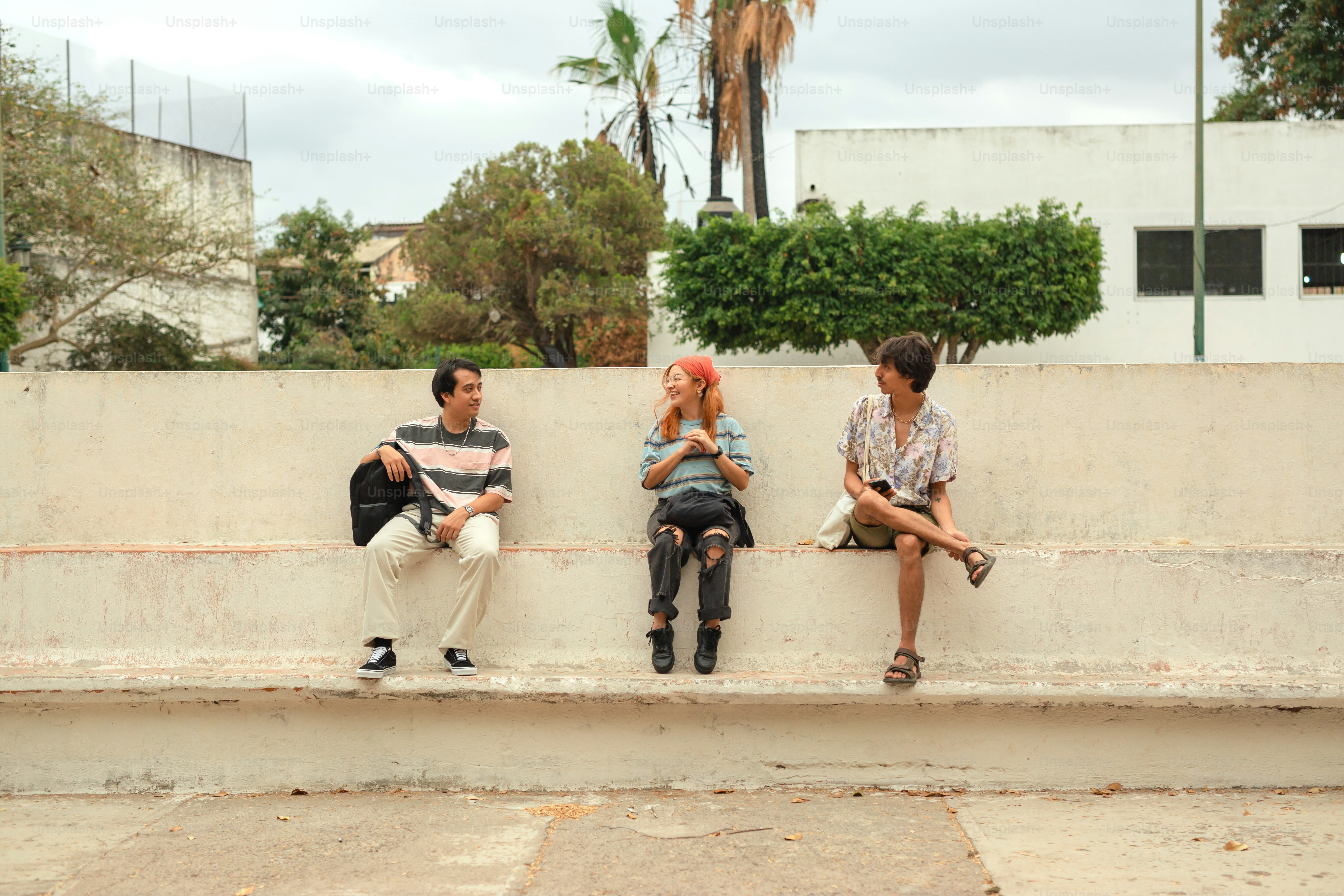 A group of people sitting next to each other photo – Gen z Image on ...